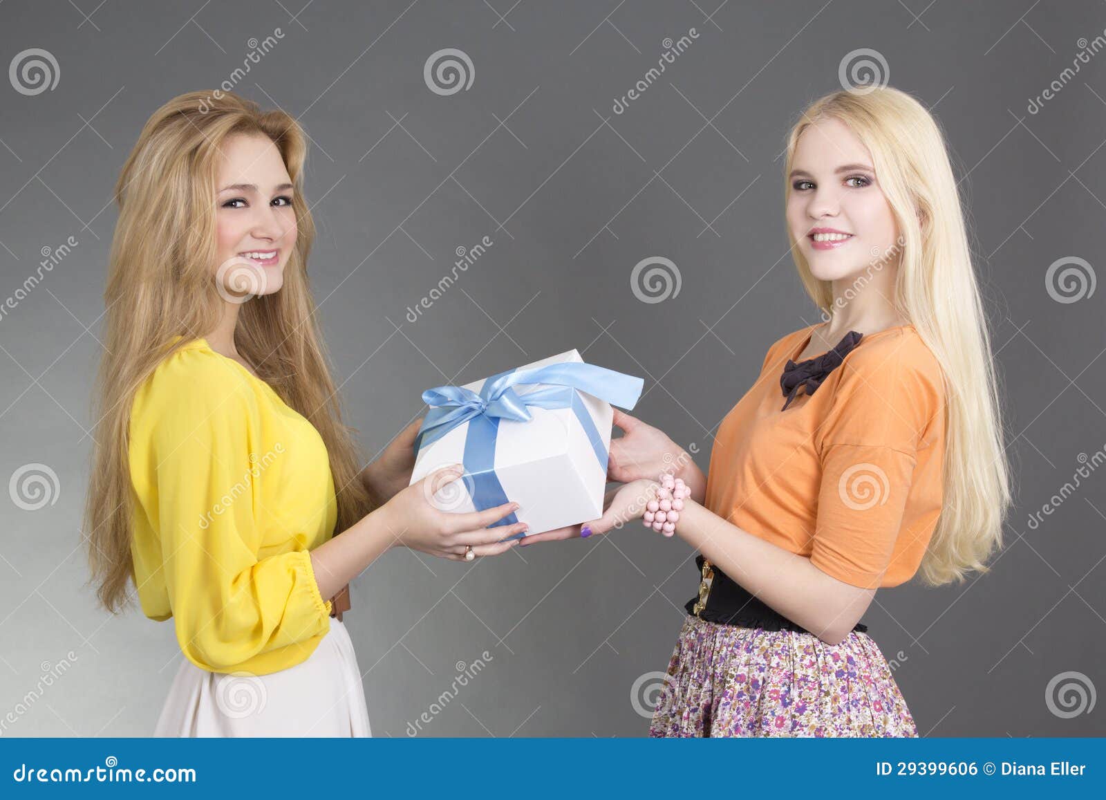 Two women with a gift box stock photo. Image of blond - 29399606