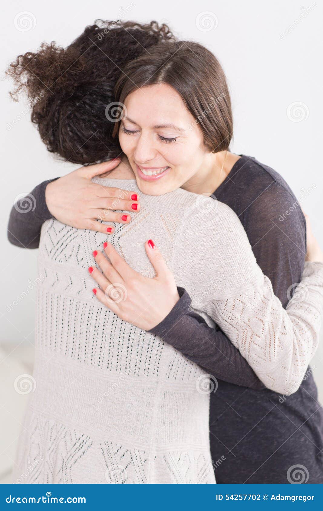 Two women giving a hug stock photo. Image of girlfriends - 54257702