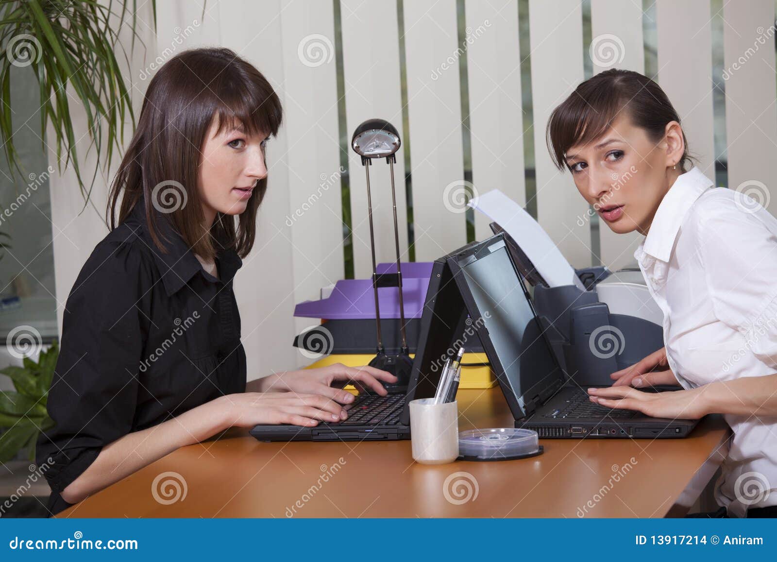 Two women gossip in office stock photo. Image of business - 13917214