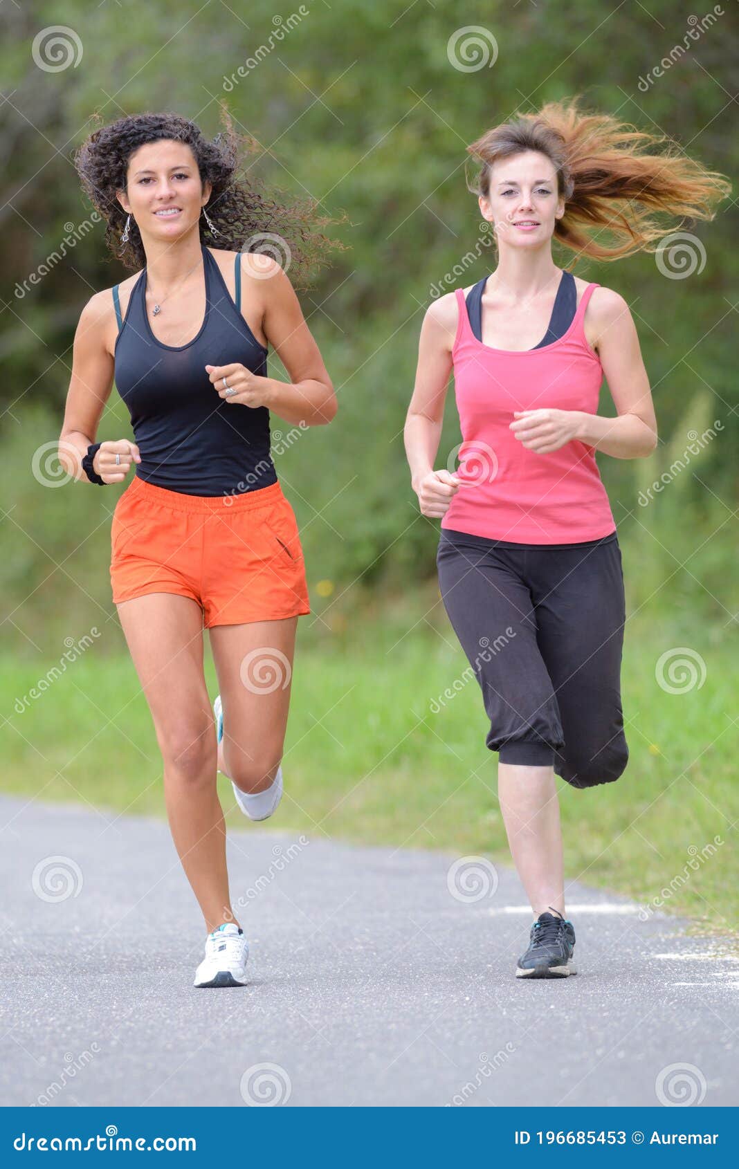 Two women jogging outdoors stock image. Image of recreation - 196685453