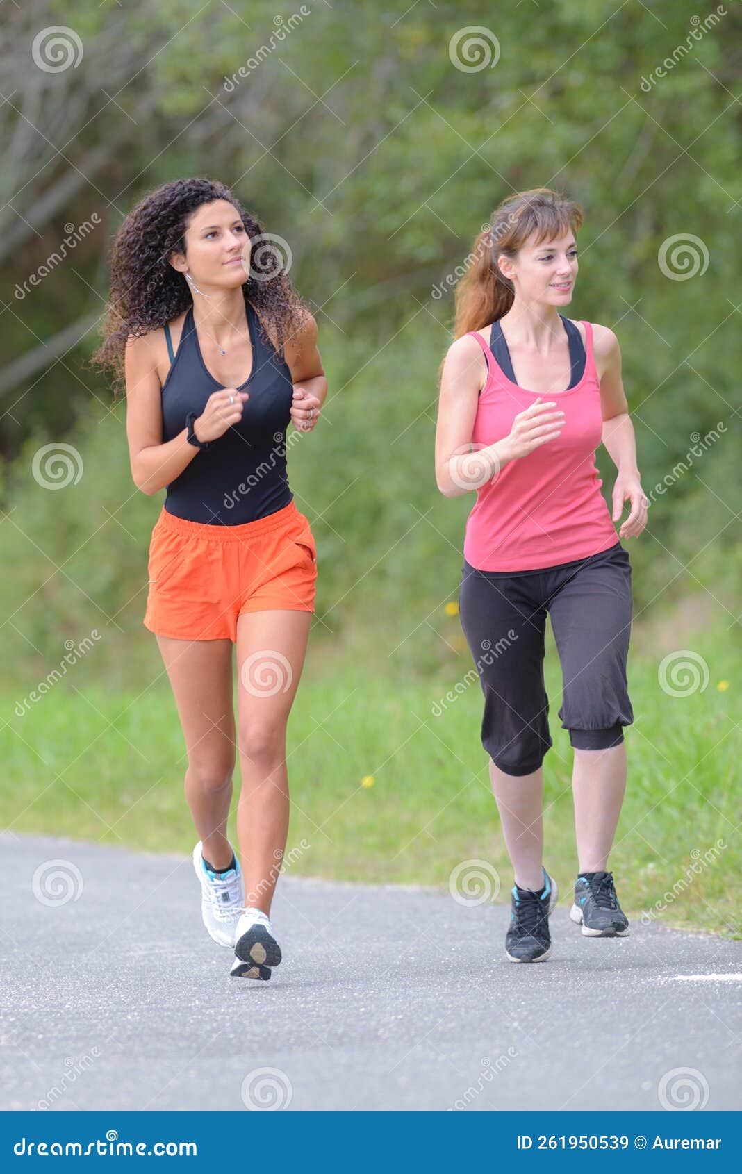 Two women jogging outdoors stock image. Image of routine - 261950539