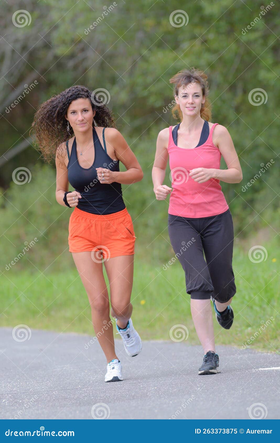 Two women jogging outdoors stock image. Image of health - 263373875