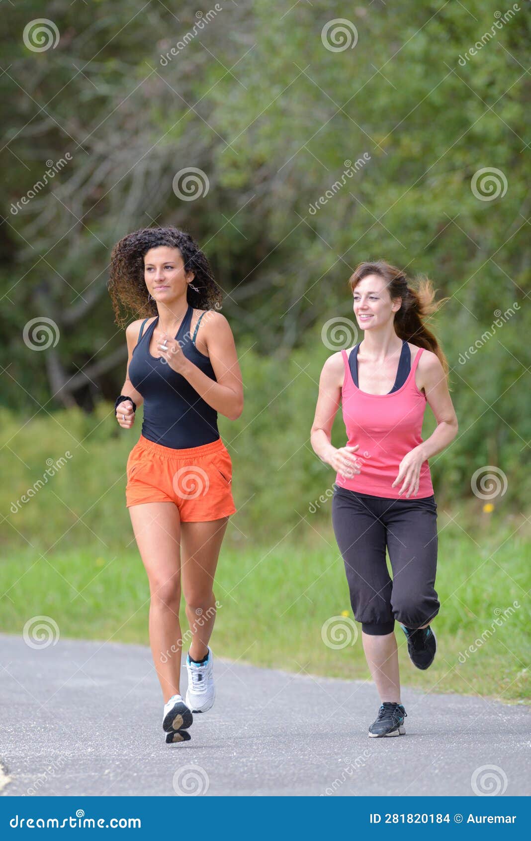 Two women jogging outdoors stock photo. Image of women - 281820184