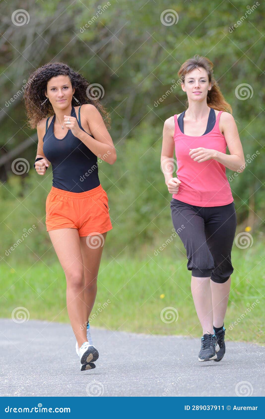 Two women jogging outdoors stock image. Image of activewear - 289037911