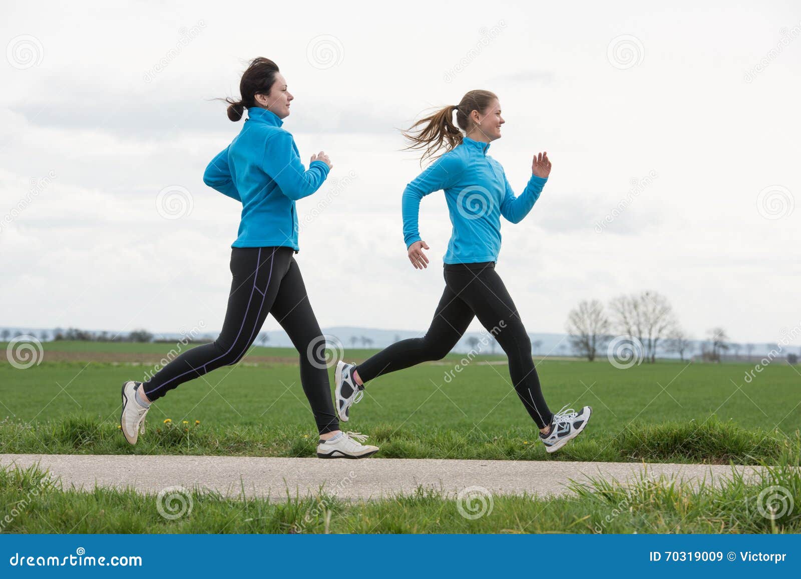 Two women jogging outdoors stock image. Image of running - 70319009