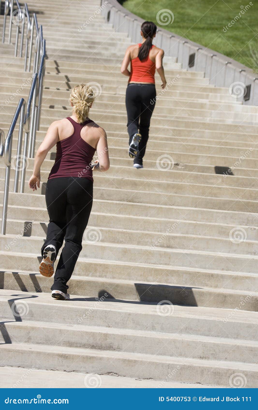 Two women jogging up steps stock image. Image of effort - 5400753