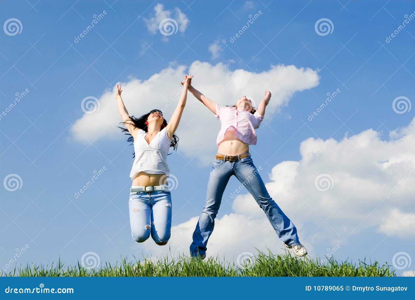 Two Women Jumping on the Green Grass Stock Image - Image of life, adult ...