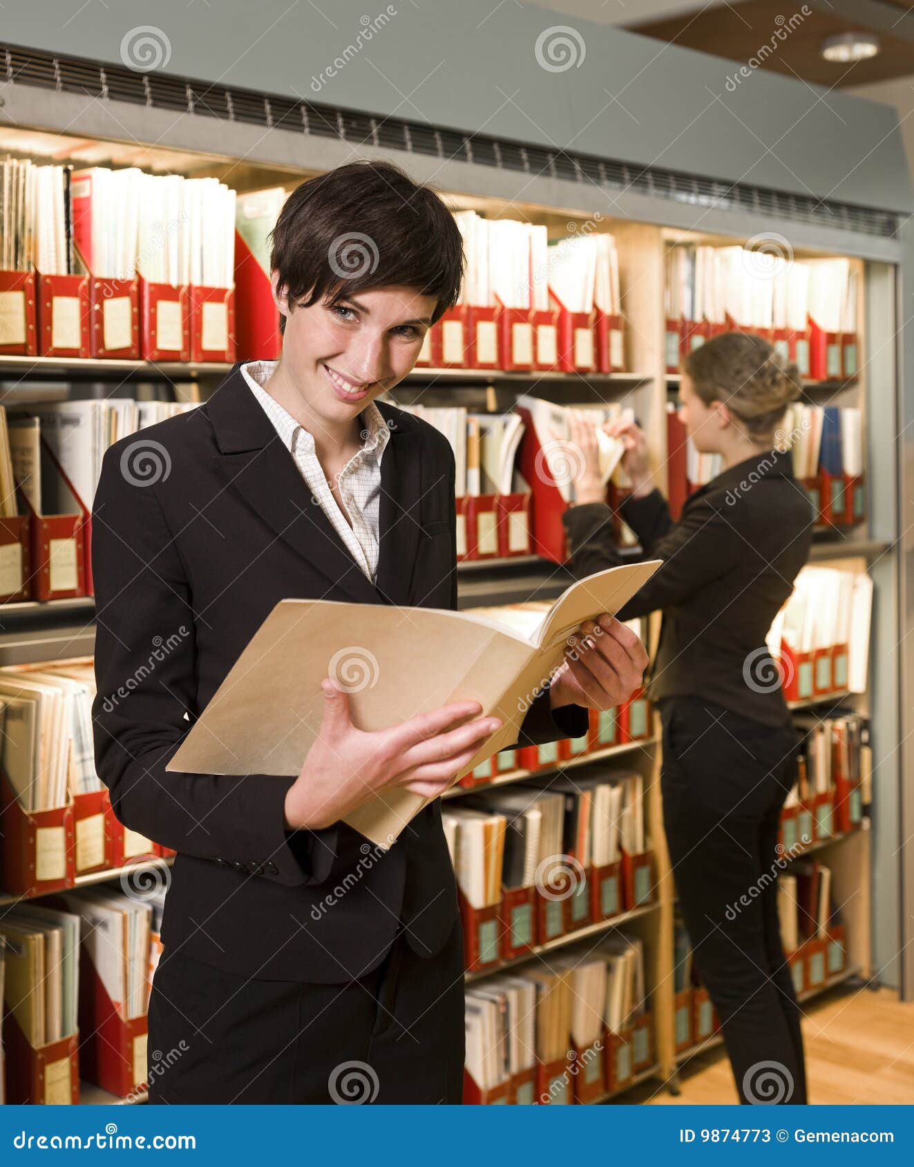 Two women at a library stock image. Image of people, reaching - 9874773