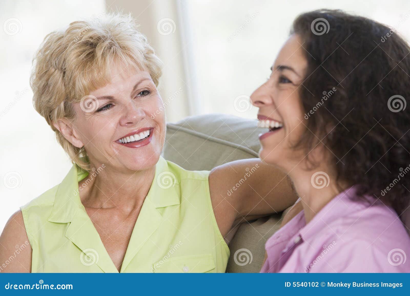 Two Women in Living Room Talking and Smiling Stock Photo - Image of ...