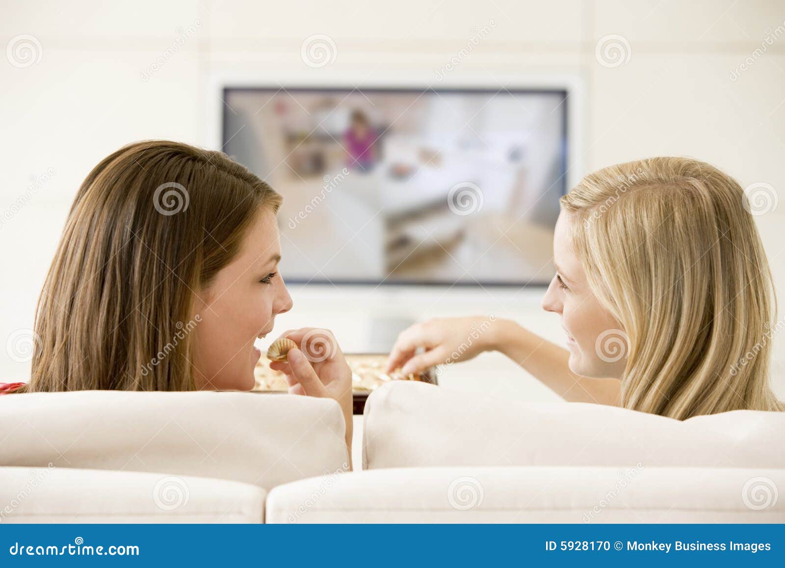 Two Women in Living Room Watching Television Stock Photo - Image of ...