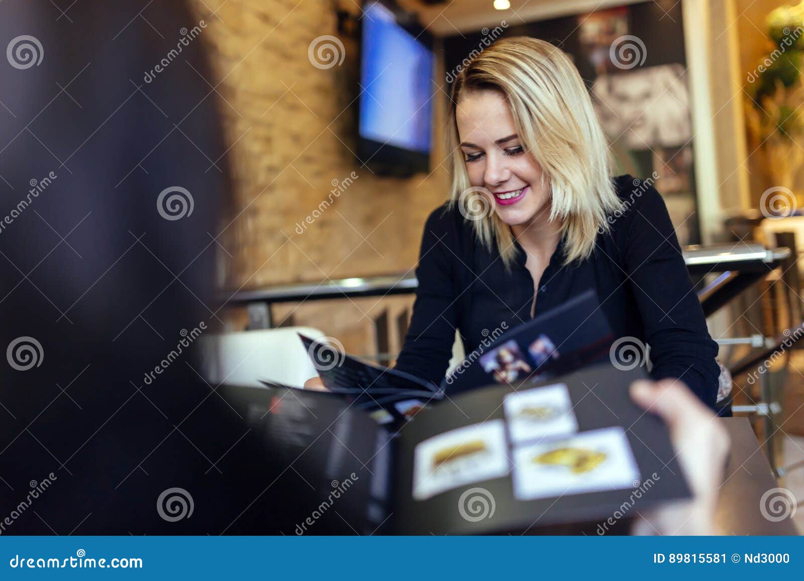 Two women looking at menu stock image. Image of adult - 89815581