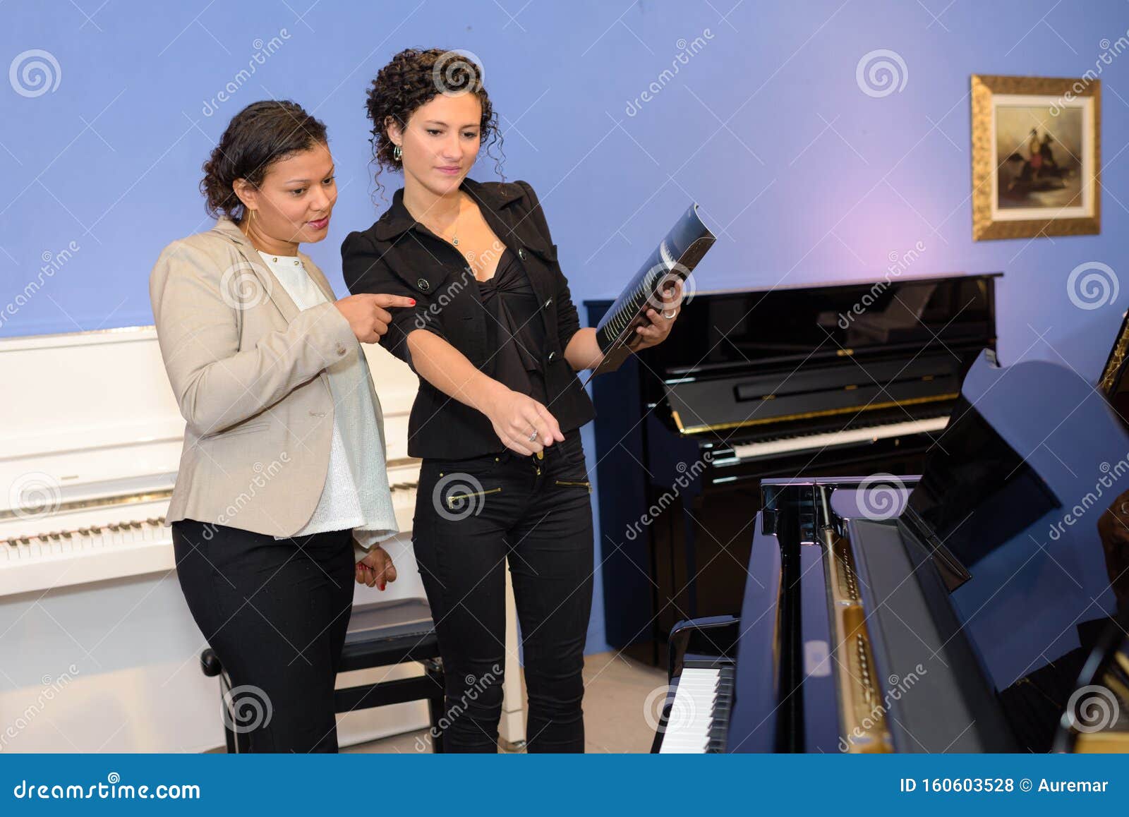 Two Women Looking at Pianos Stock Photo - Image of beauty, instrument ...