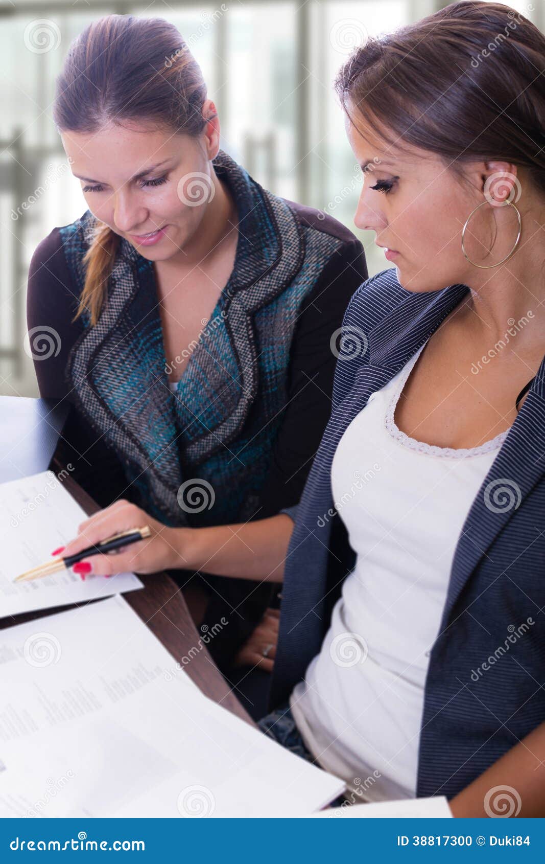 Two women in a meeting stock photo. Image of document - 38817300