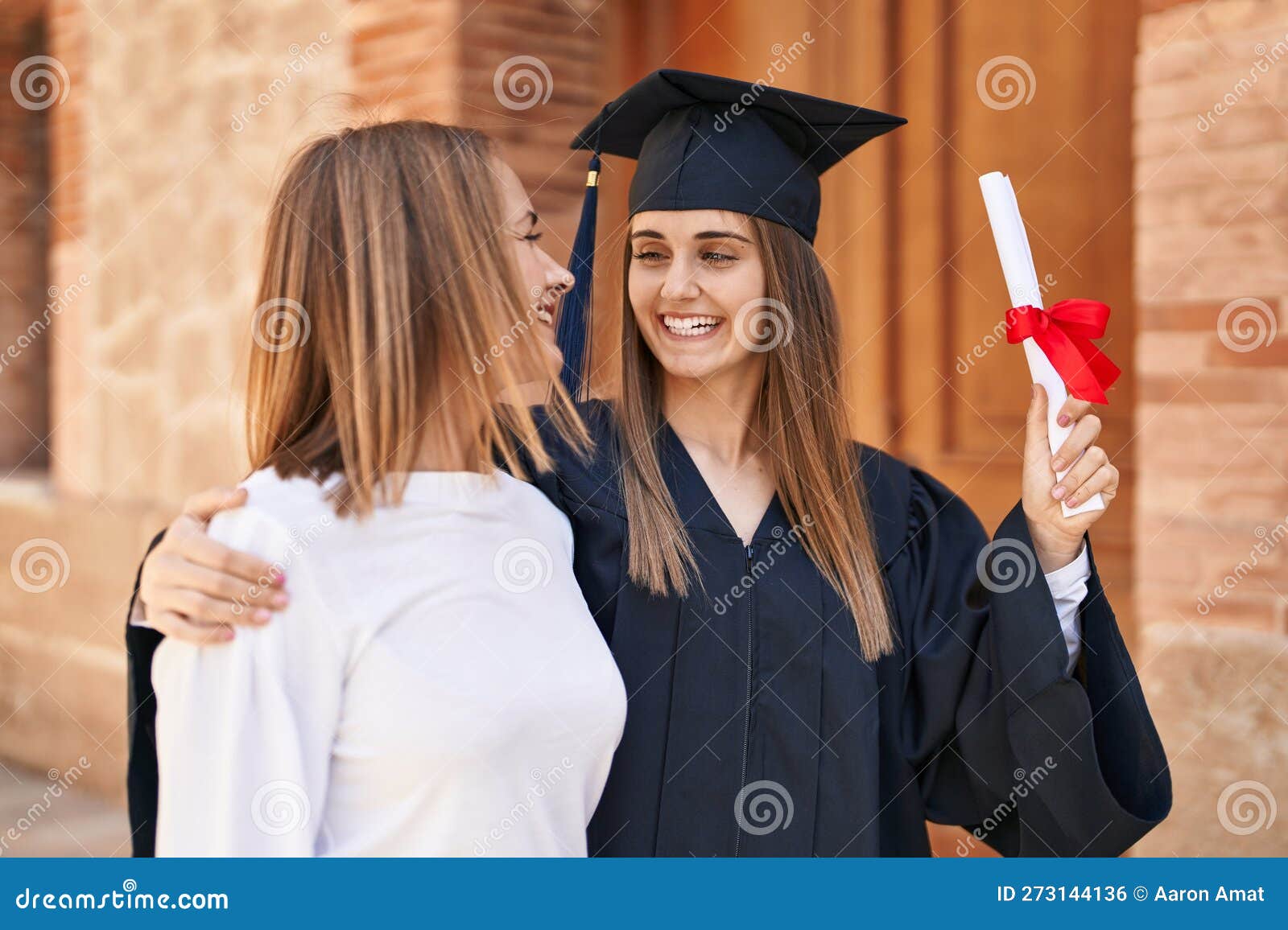 Two Women Mother And Graduated Daughter Standing Together At Campus