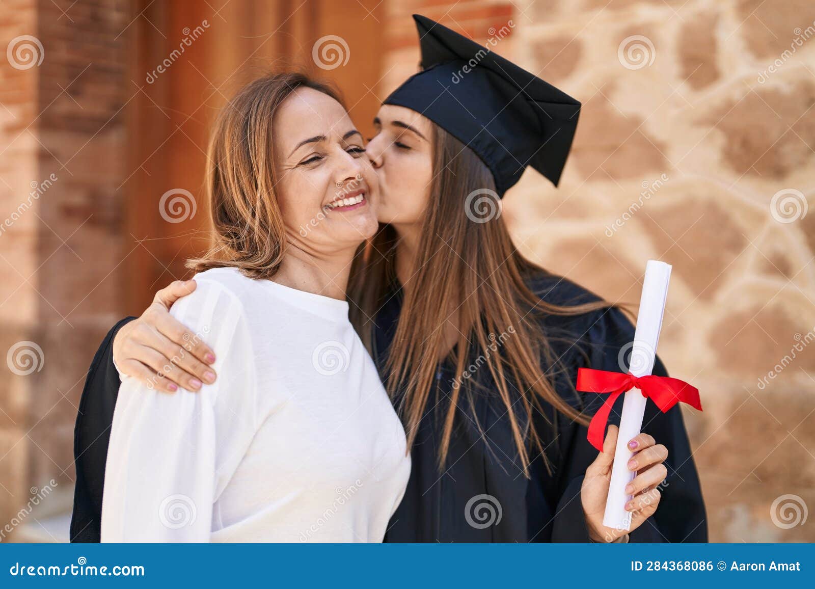 Two Women Mother And Graduated Daughter Standing Together At Campus
