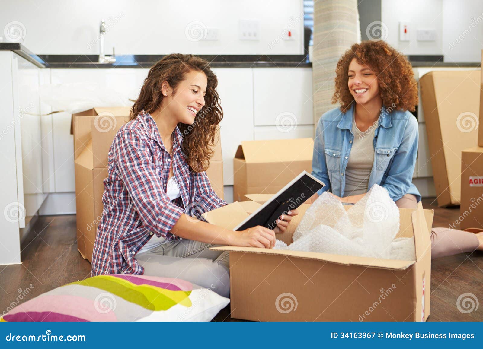 Two Women Moving into New Home and Unpacking Boxes Stock Image - Image ...