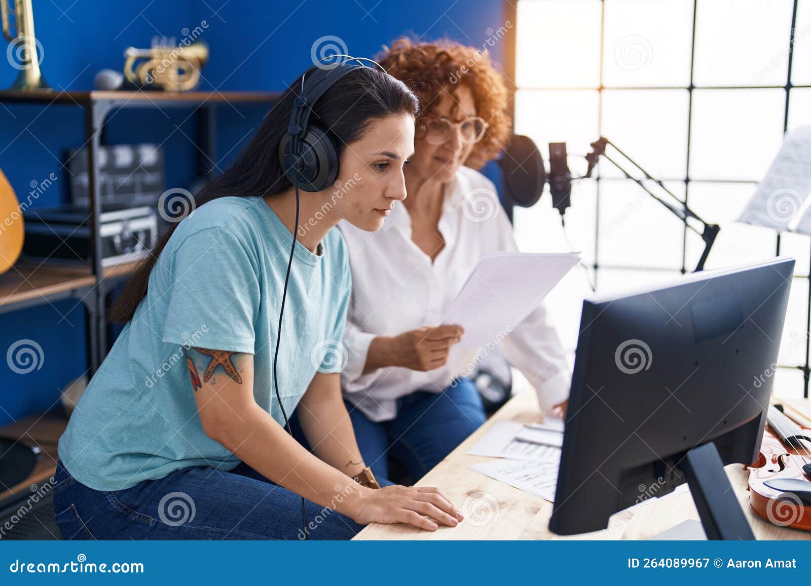 Two Women Musicians Composing Song Using Computer at Music Studio Stock ...