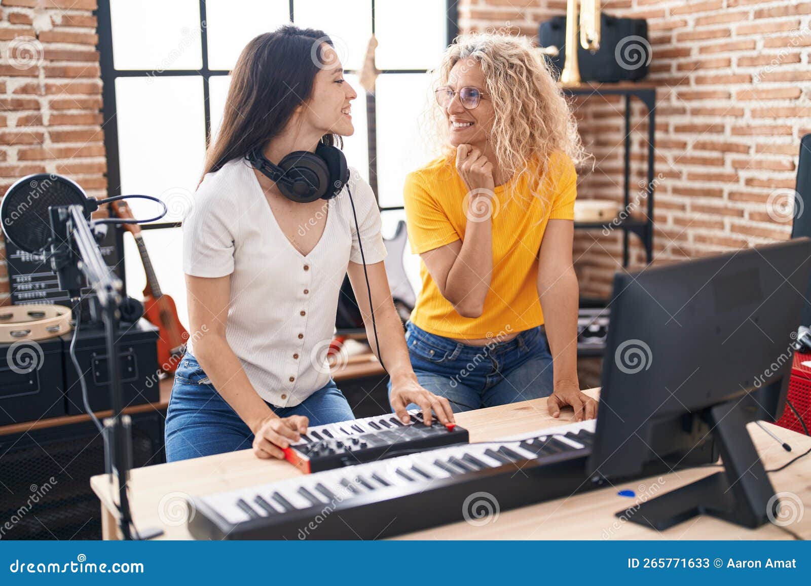 Two Women Musicians Composing Song Using Keyboard at Music Studio Stock ...