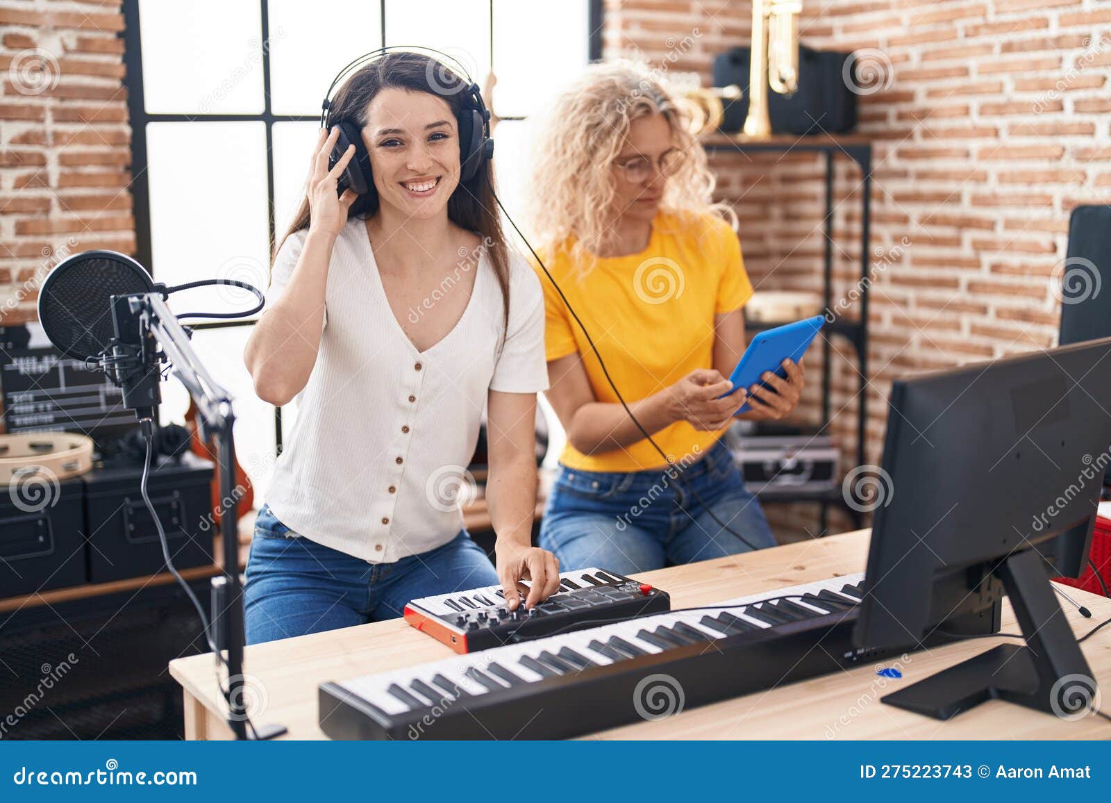 Two Women Musicians Composing Song Using Keyboard and Touchpad at Music ...