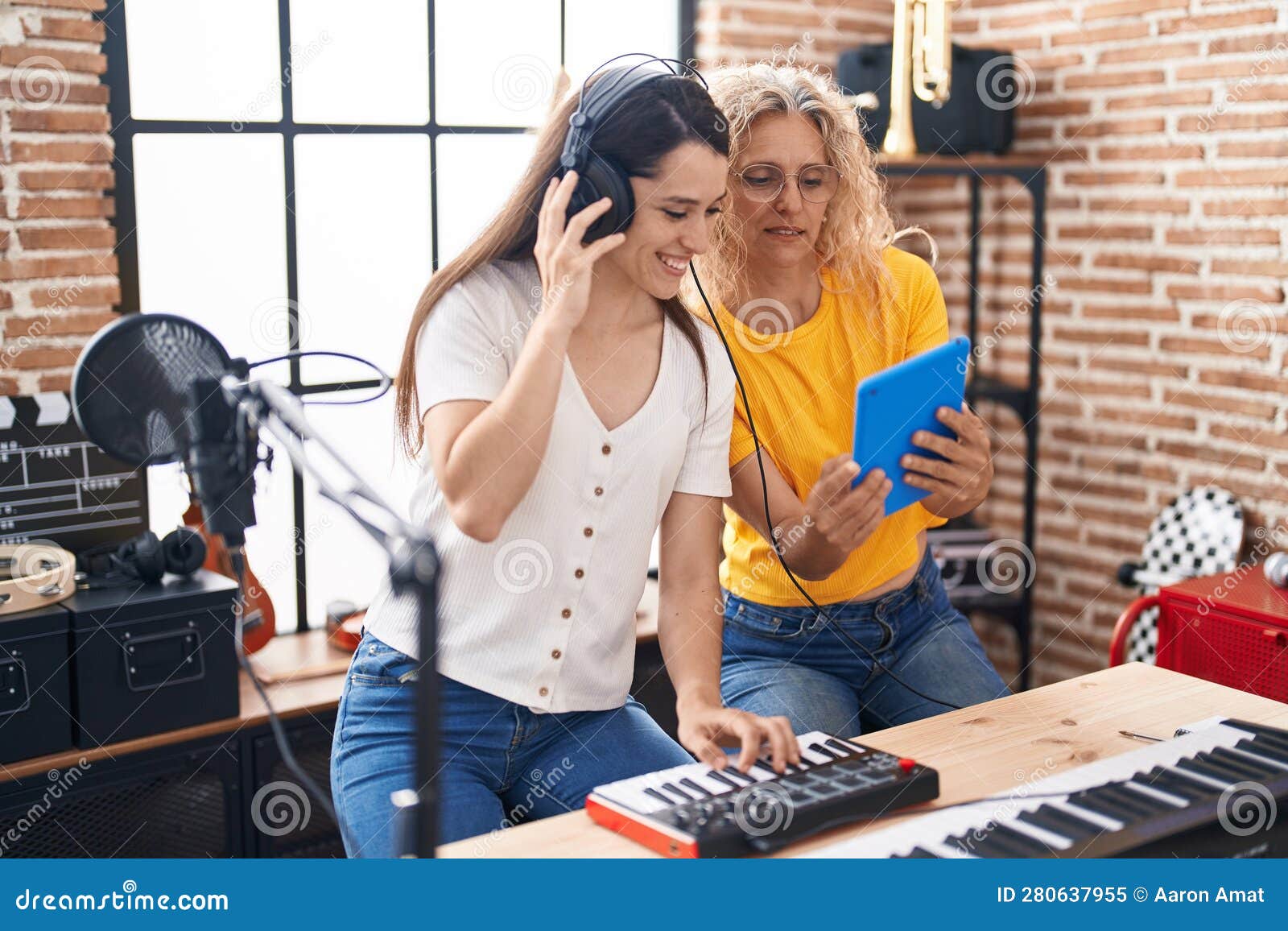 Two Women Musicians Composing Song Using Keyboard and Touchpad at Music ...