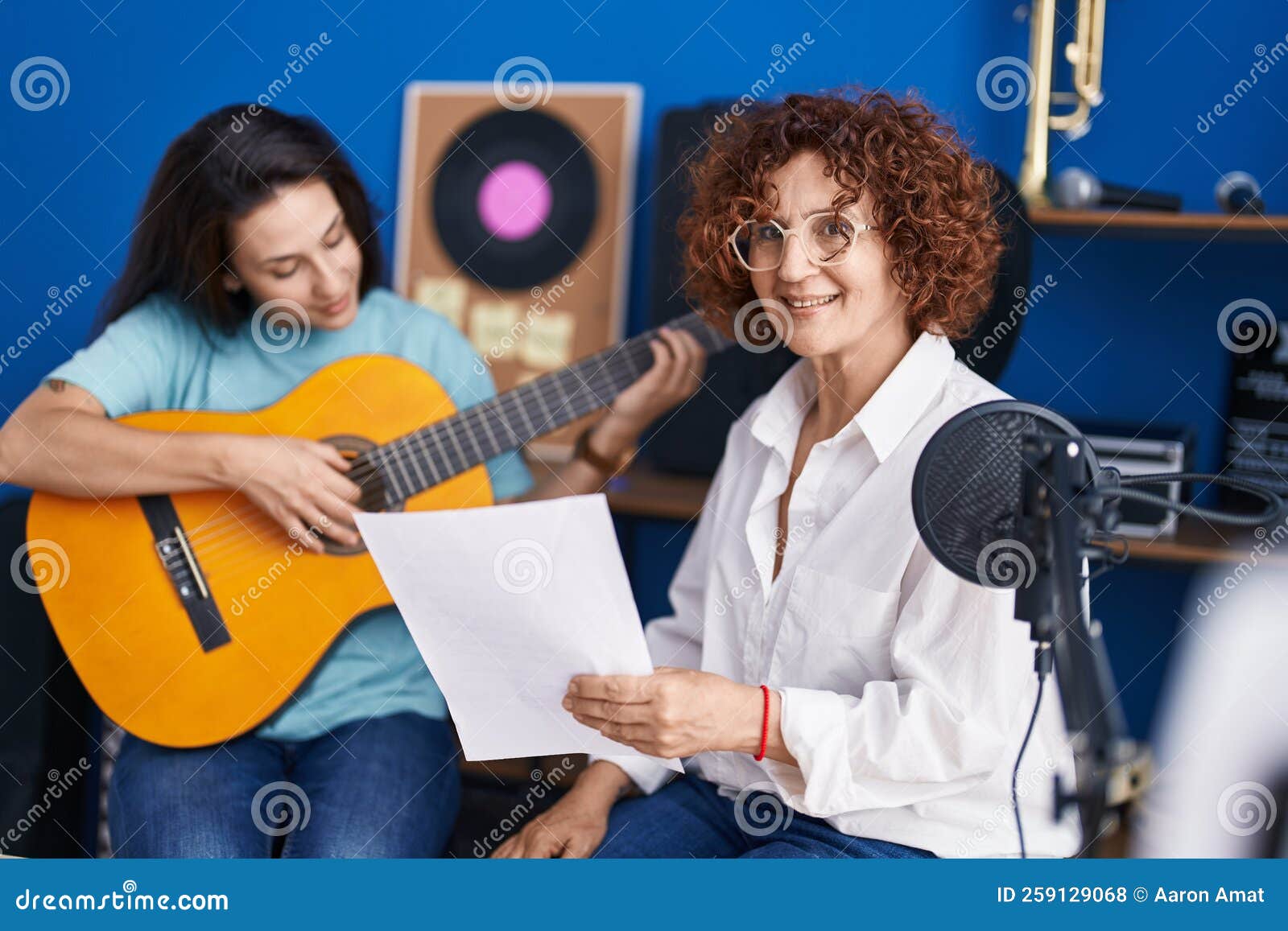 Two Women Musicians Having Classical Guitar Lesson at Music Studio ...