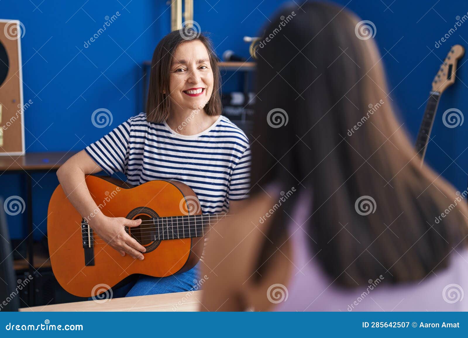 Two Women Musicians Playing Classical Guitar at Music Studio Stock ...
