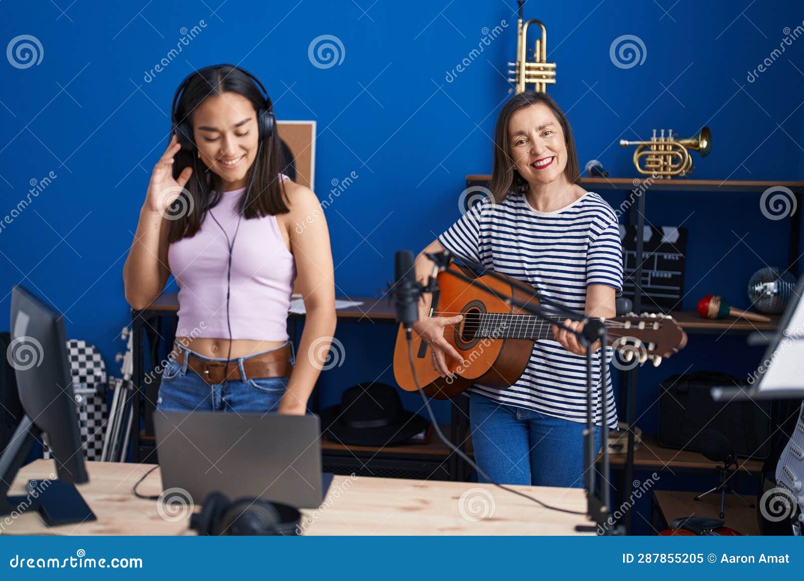 Two Women Musicians Playing Classical Guitar Using Laptp at Music ...