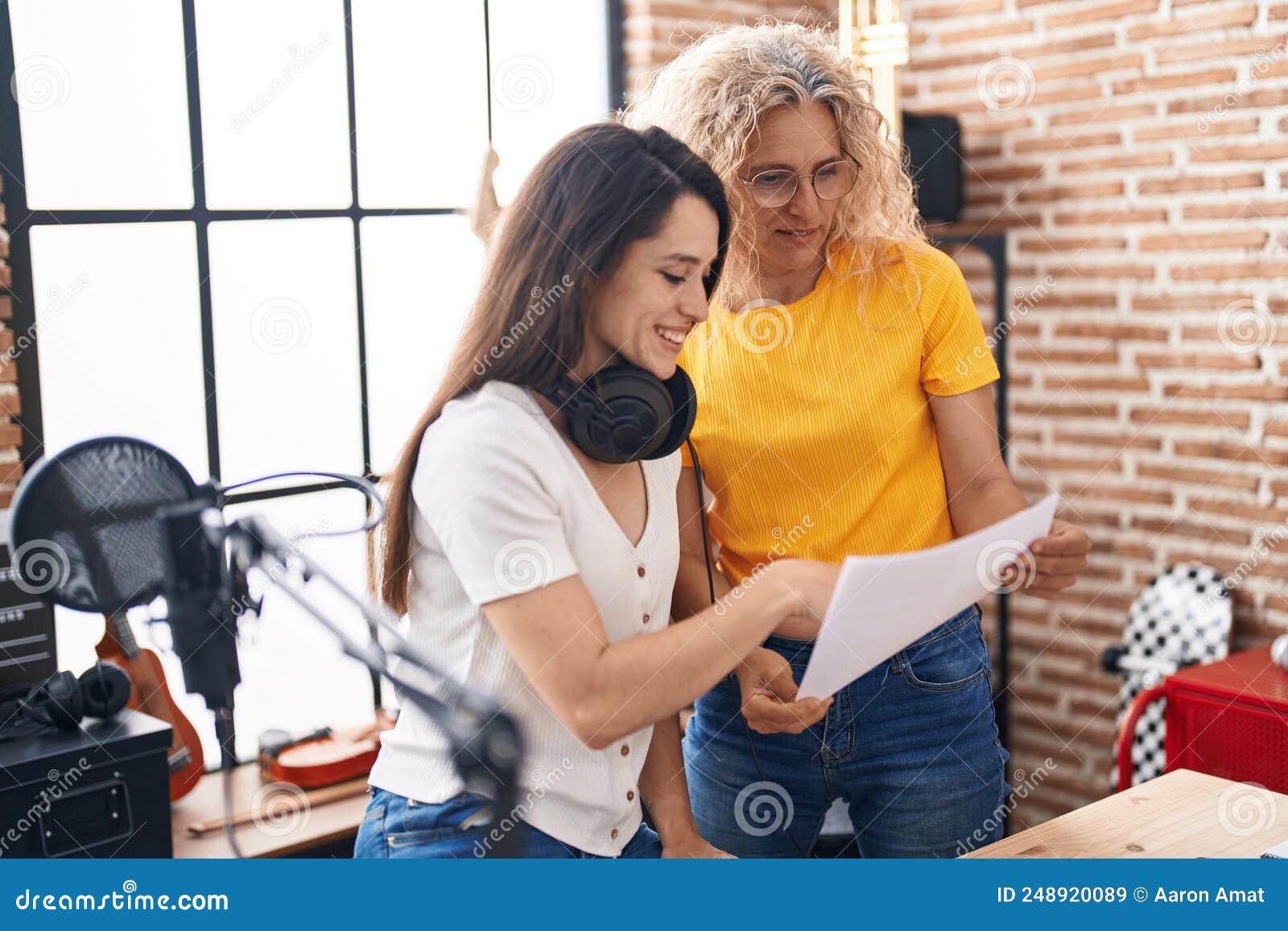 Two Women Musicians Reading Music Sheet at Music Studio Stock Image ...