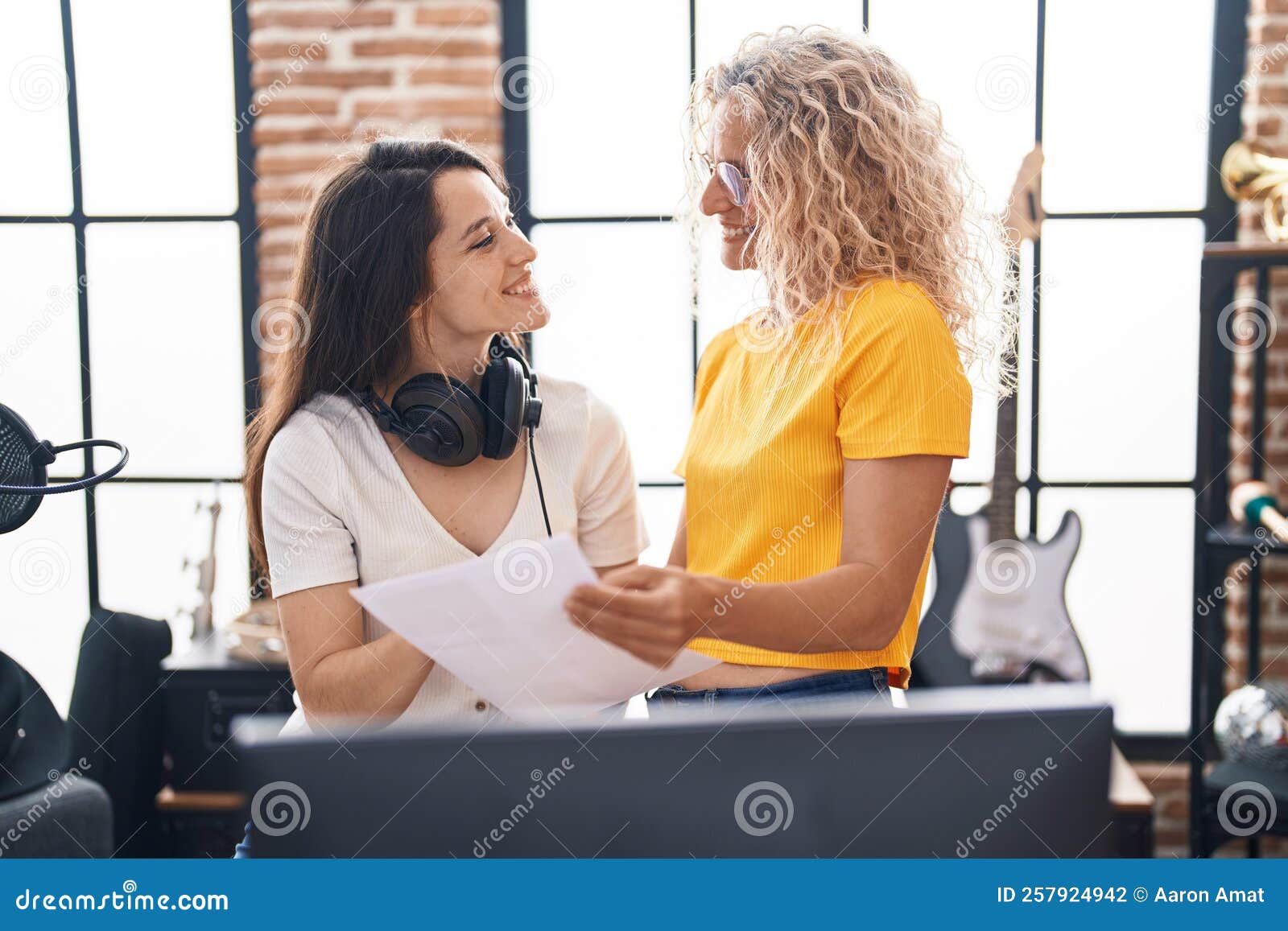 Two Women Musicians Reading Music Sheet at Music Studio Stock Photo ...