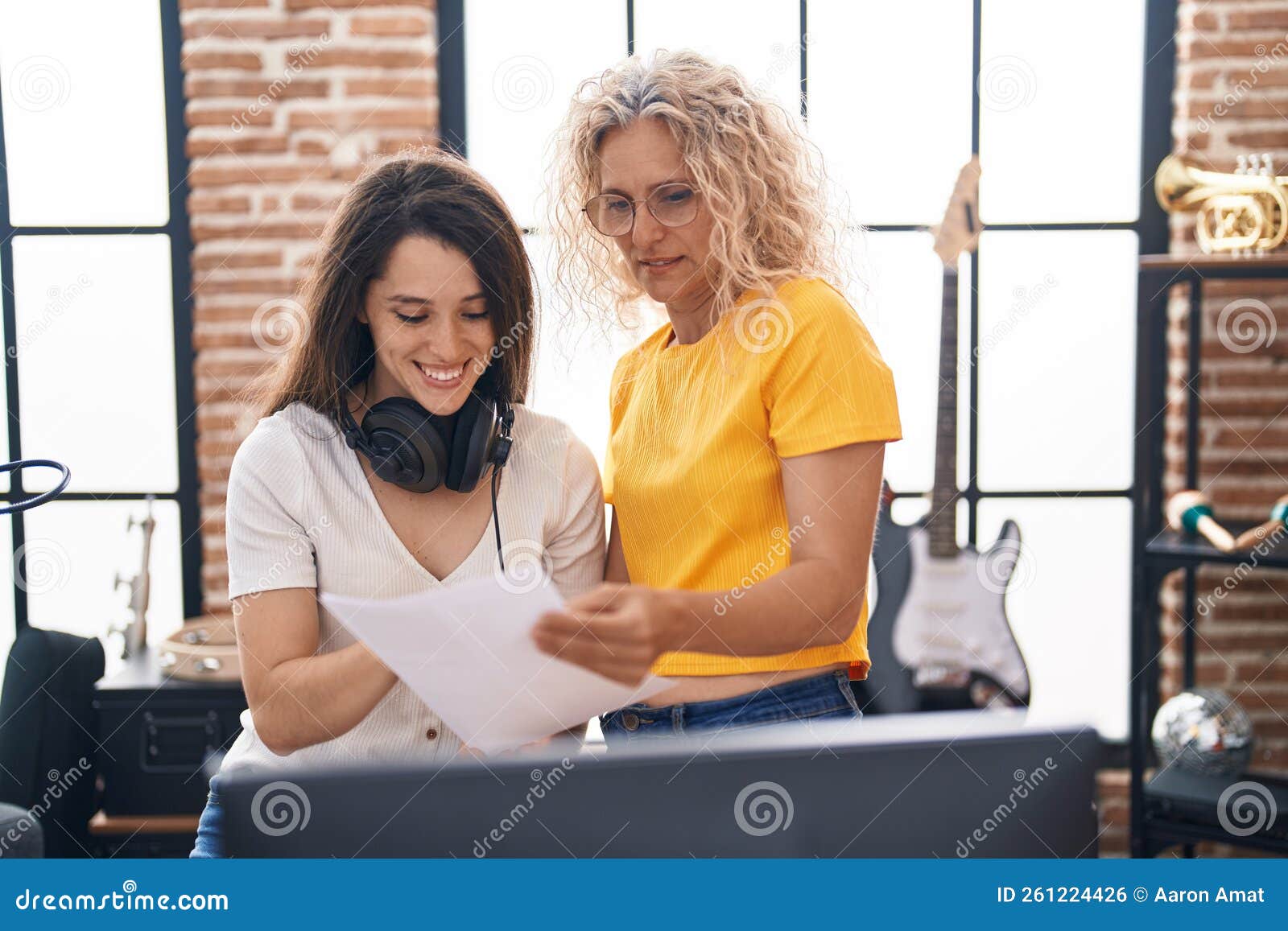 Two Women Musicians Reading Music Sheet at Music Studio Stock Photo ...