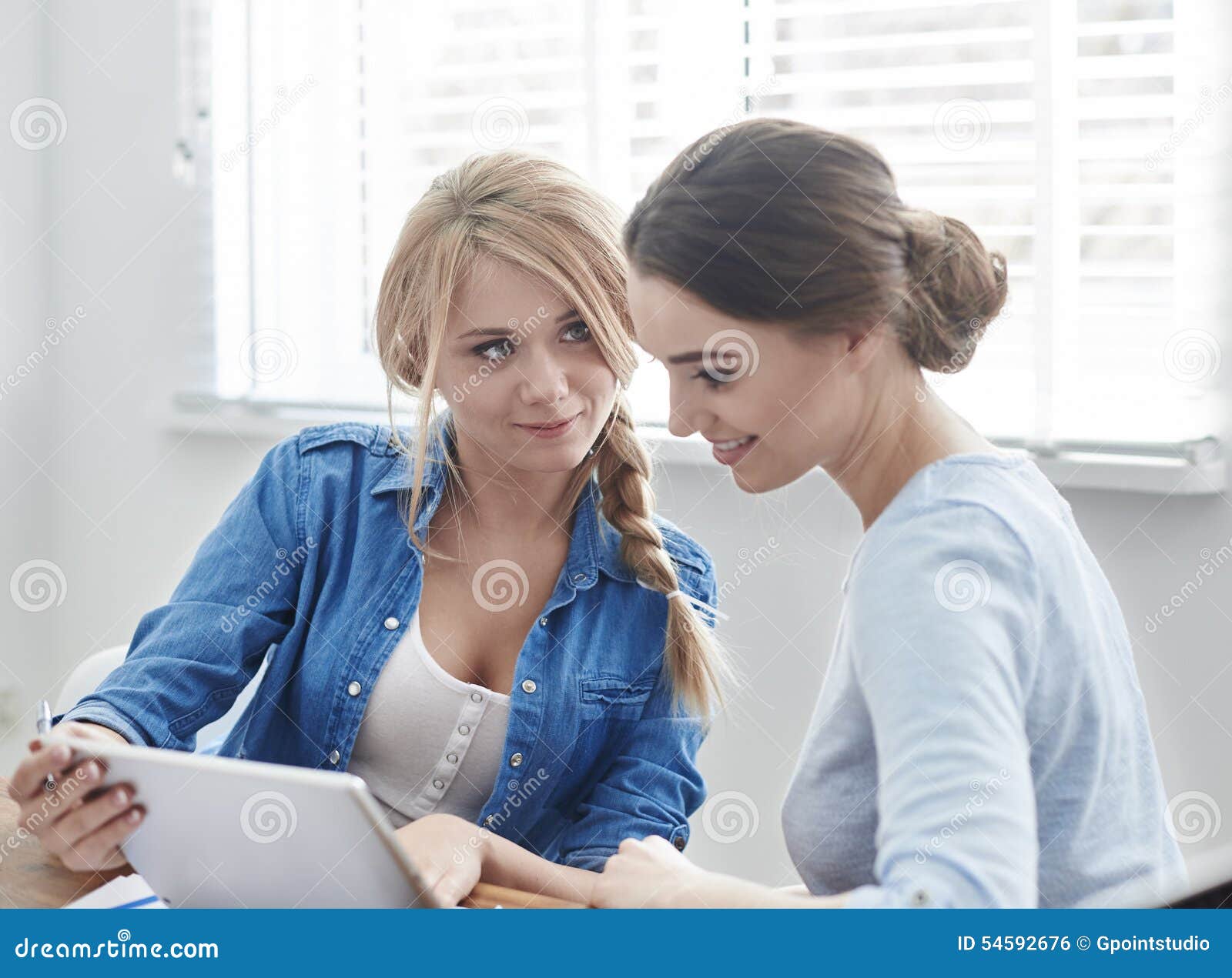 Two women at office stock photo. Image of office, colleague - 54592676