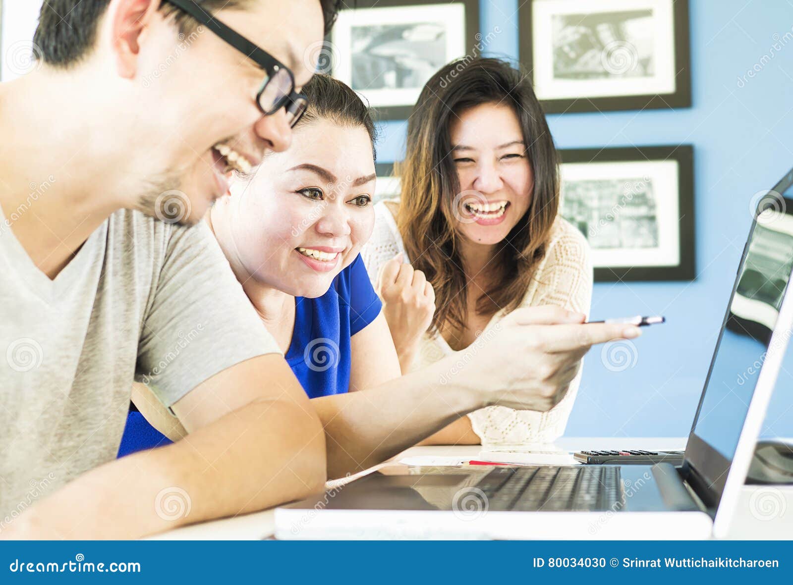 Two Women and One Man are Happily Looking at Computer Stock Photo ...
