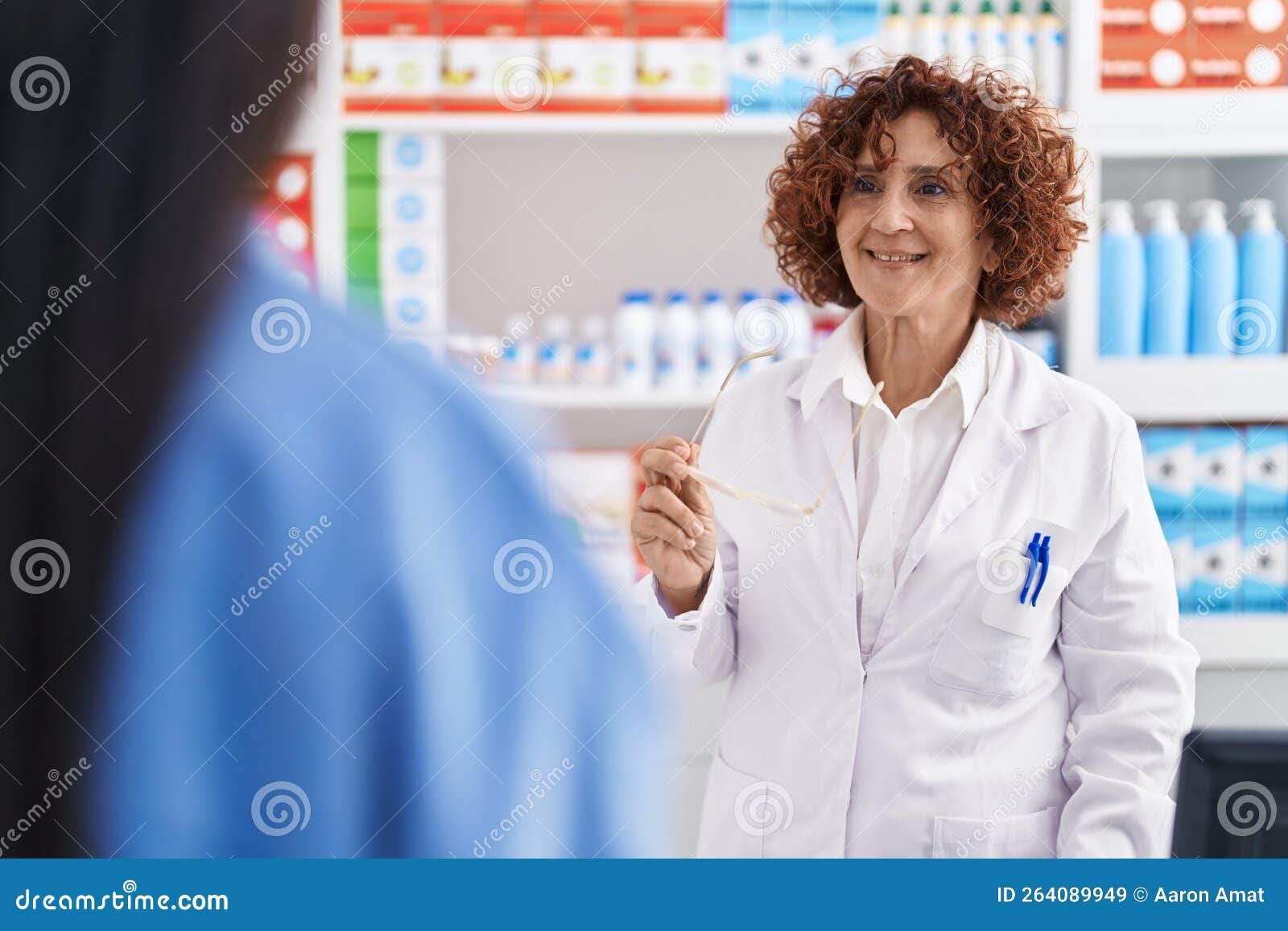Two Women Pharmacist and Customer Speaking at Pharmacy Stock Image ...