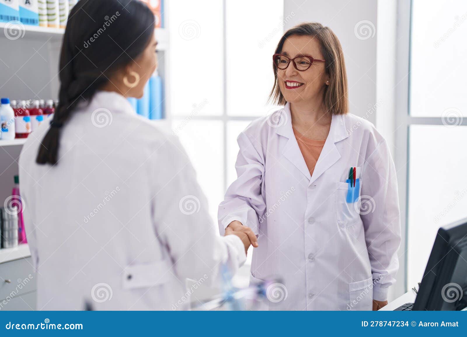 Two Women Pharmacist Smiling Confident Shake Hands at Pharmacy Stock ...
