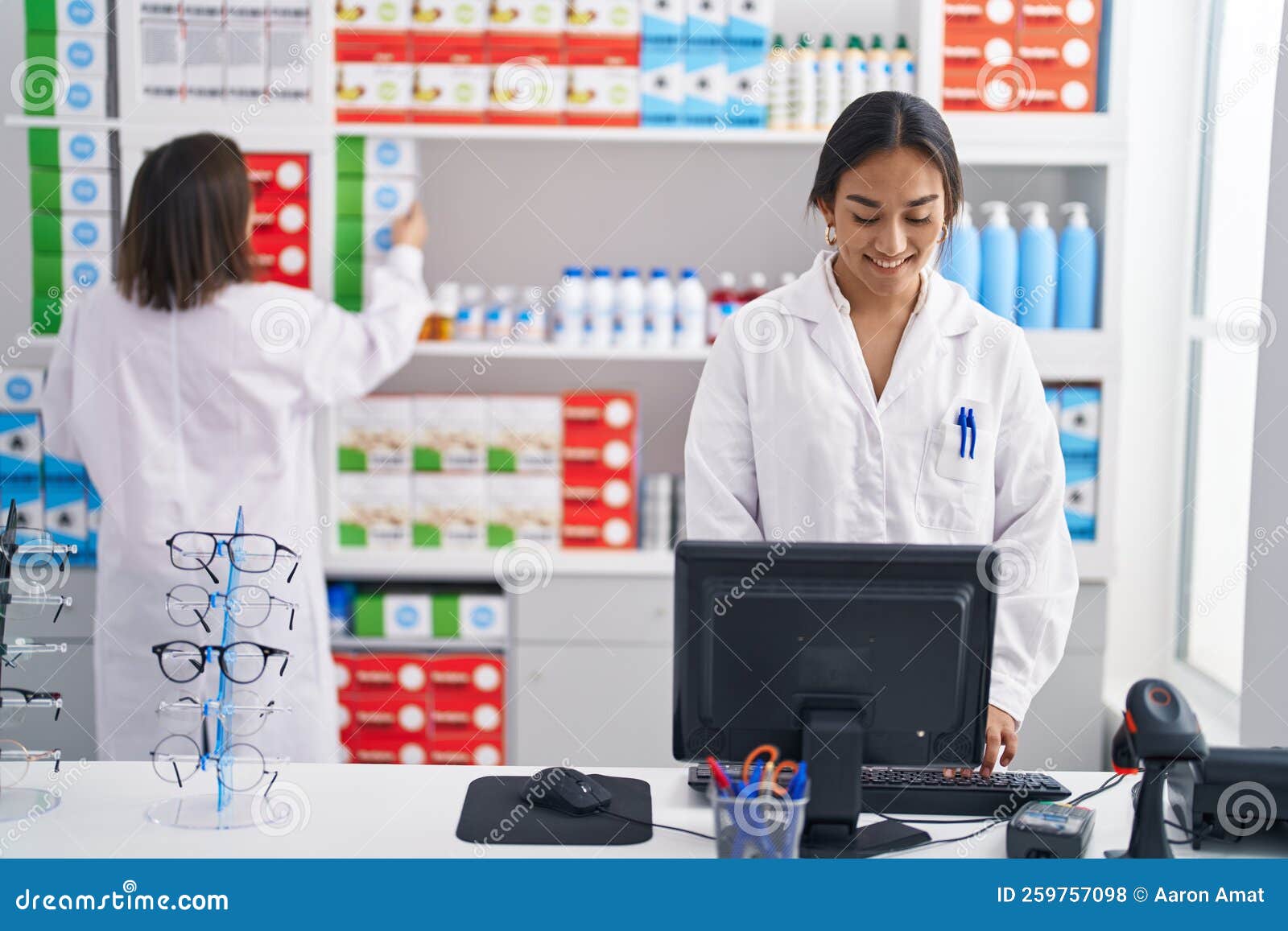 Two Women Pharmacist Using Computer Working at Pharmacy Stock Photo ...