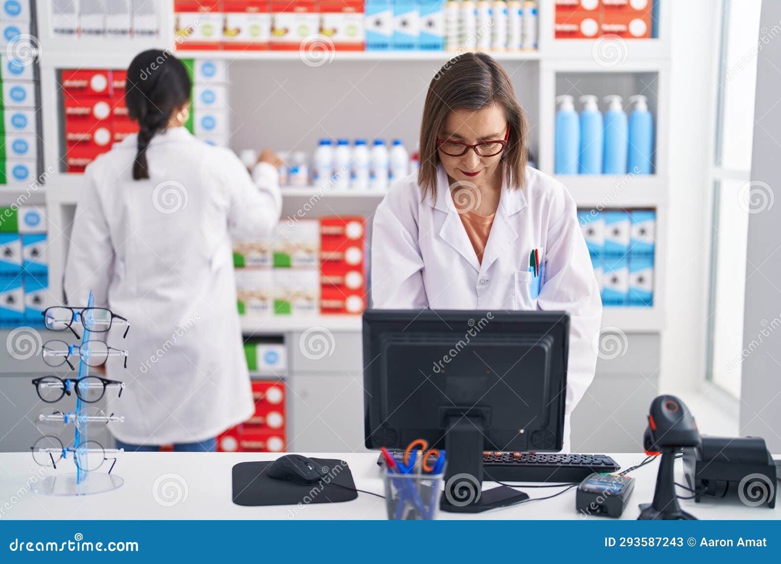 Two Women Pharmacist Using Computer Working at Pharmacy Stock Image ...