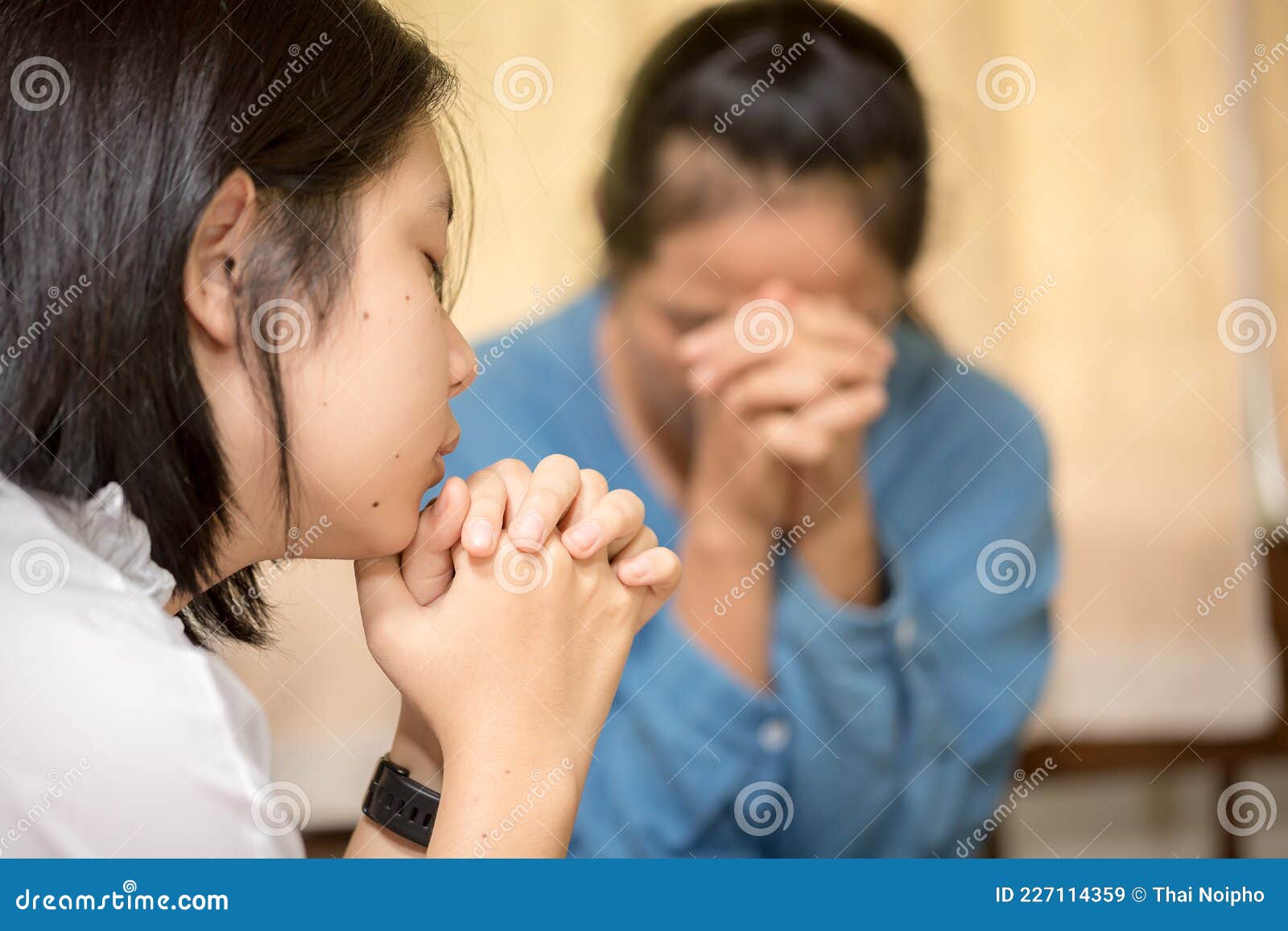 Two women praying together stock image. Image of hand - 227114359