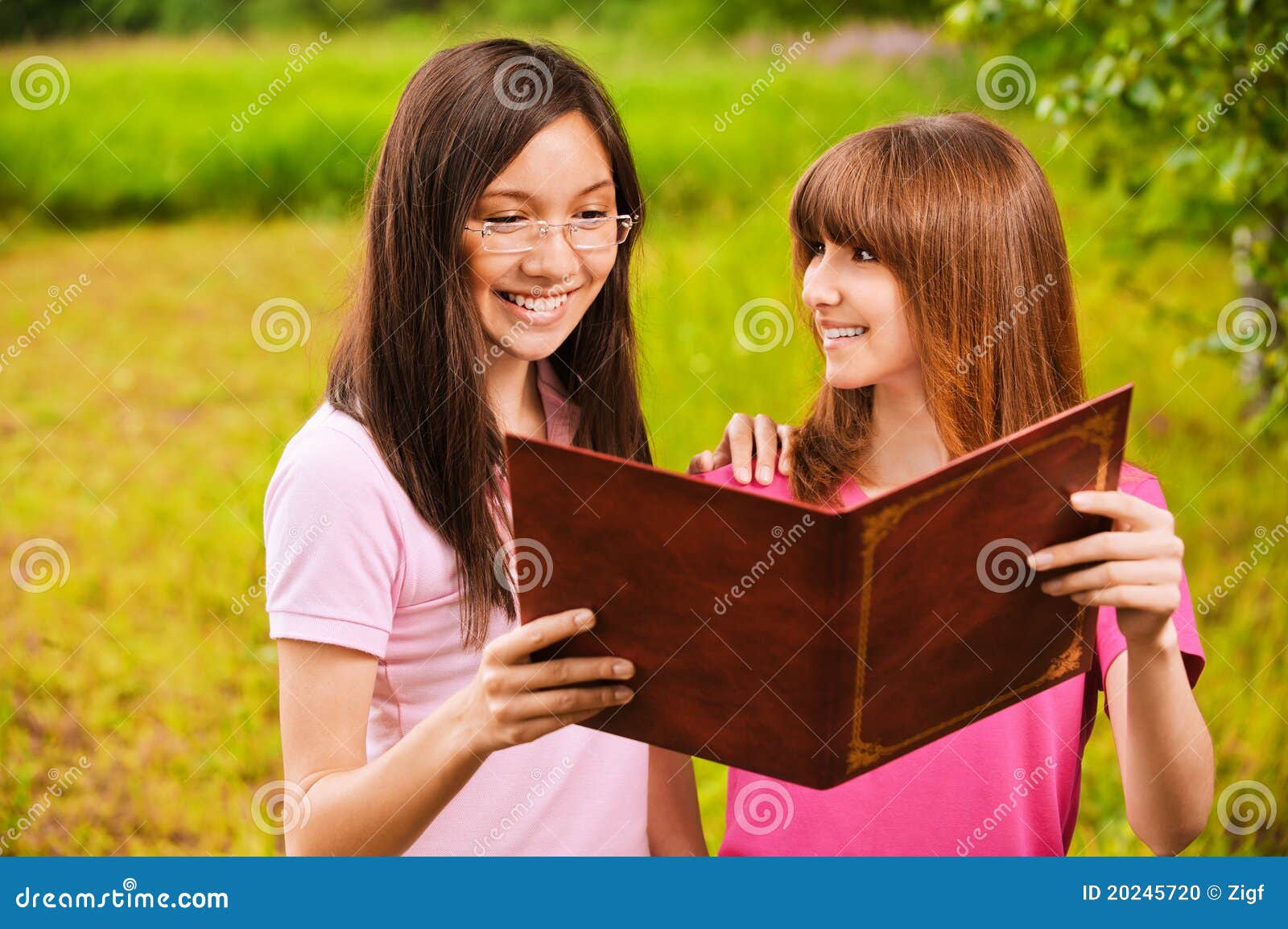 Two women read a book stock photo. Image of knowledge - 20245720