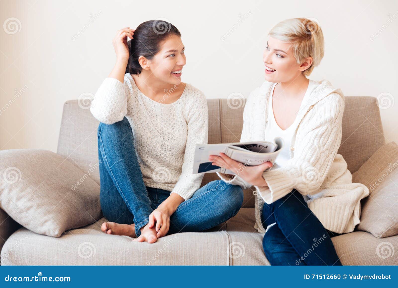 Two Women Reading Magazine on the Sofa Stock Photo - Image of reading ...