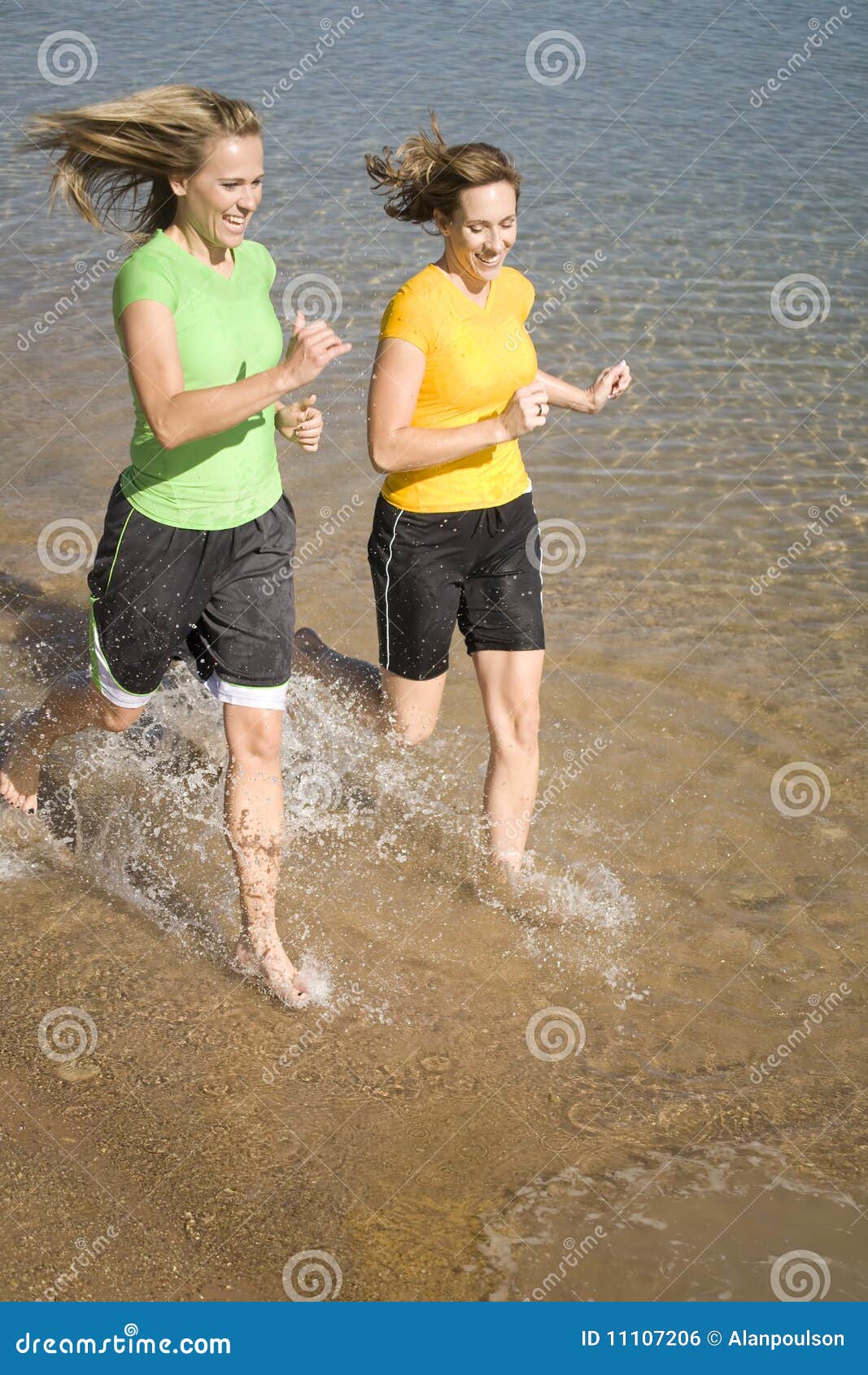 Two women run in water stock photo. Image of green, beach - 11107206