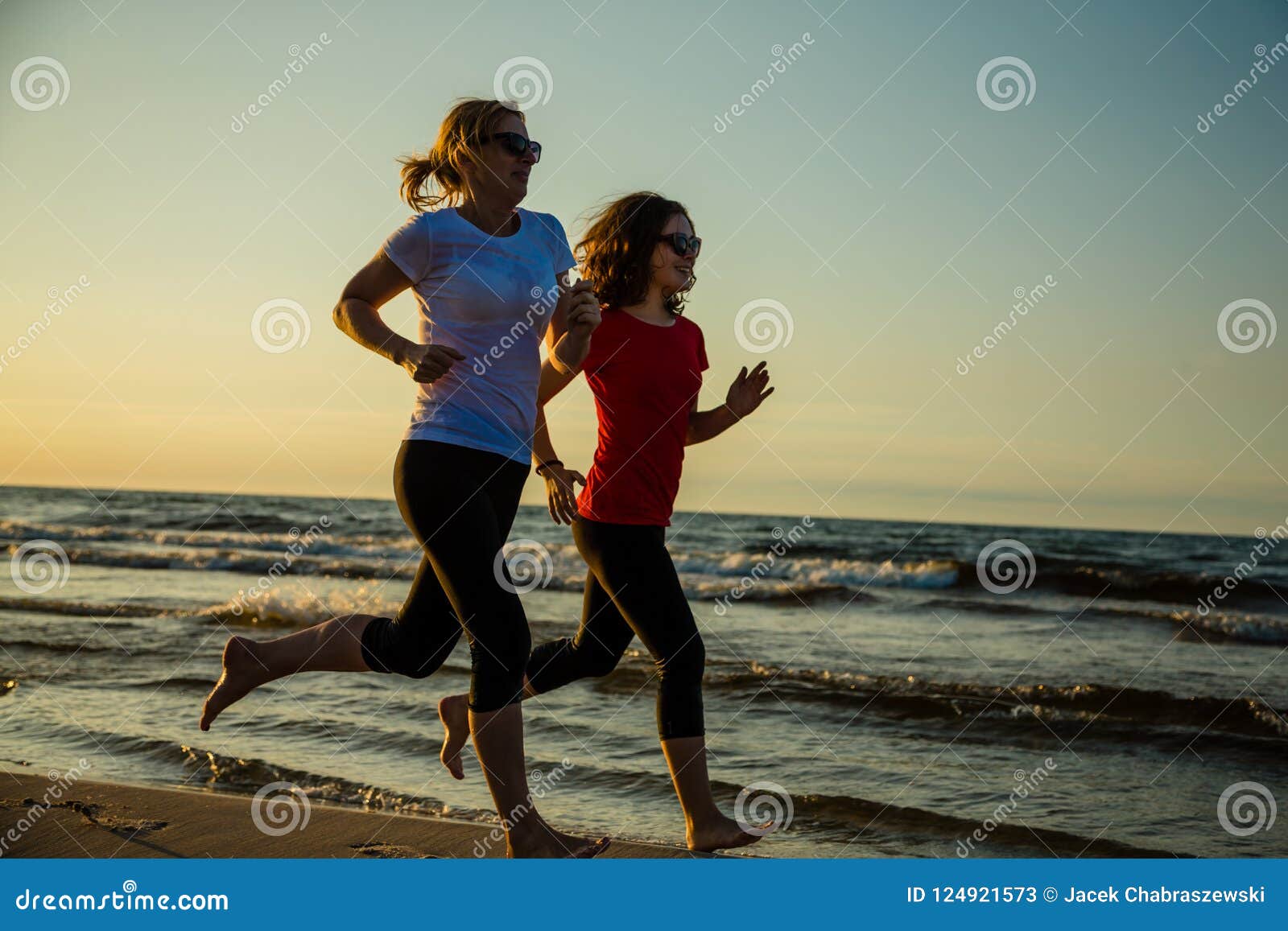 Two women running on beach stock image. Image of ocean - 124921573