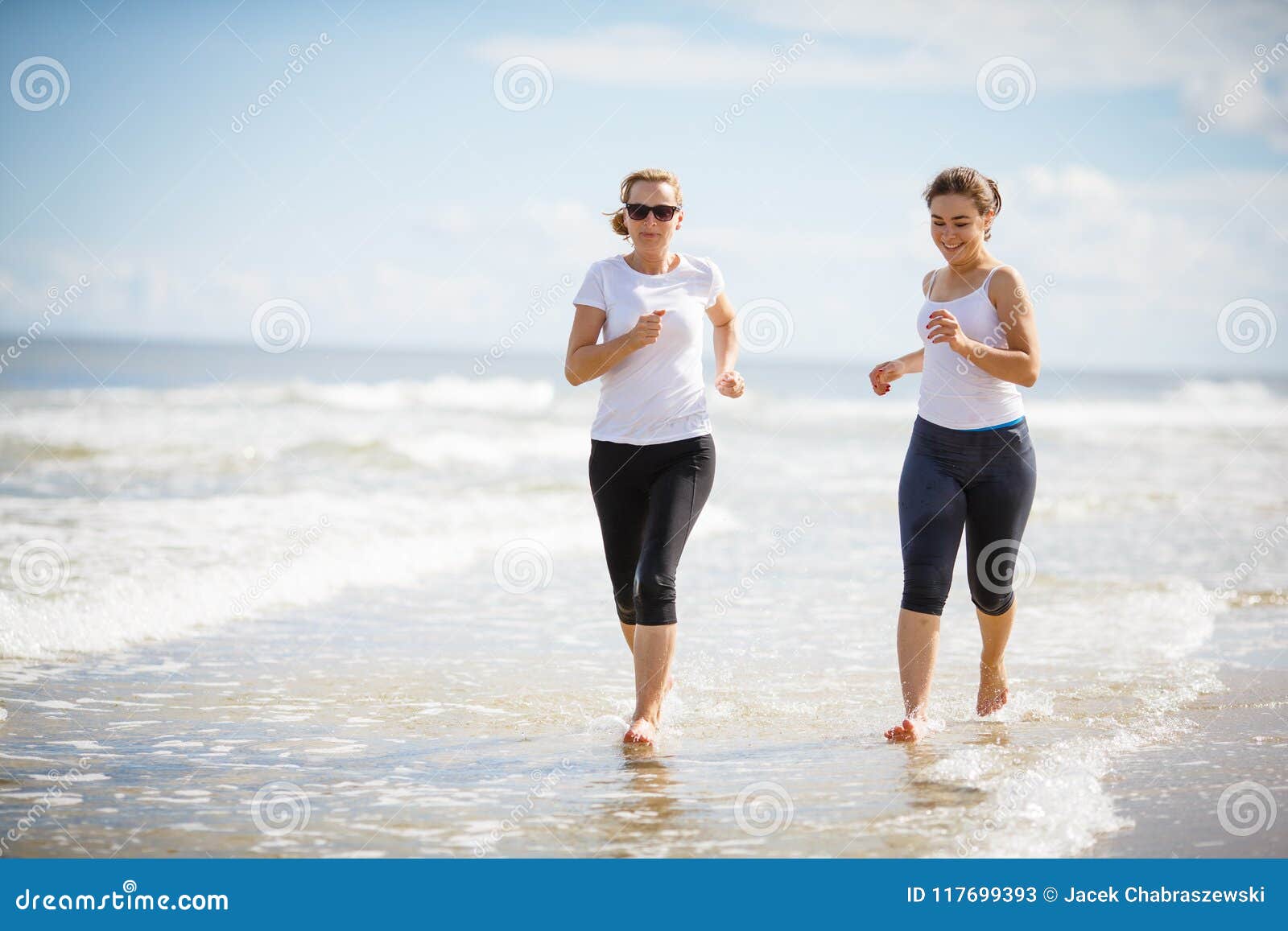Two women running on beach stock image. Image of running - 117699393