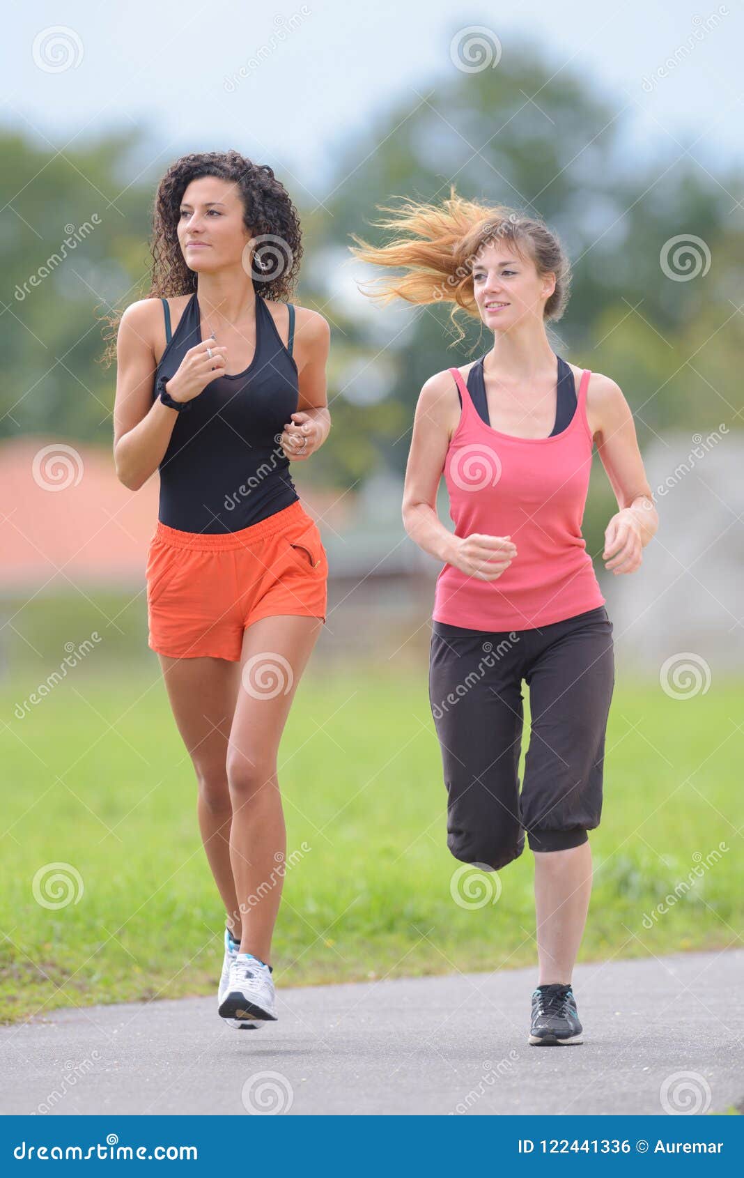 Two women running in park stock photo. Image of looking - 122441336
