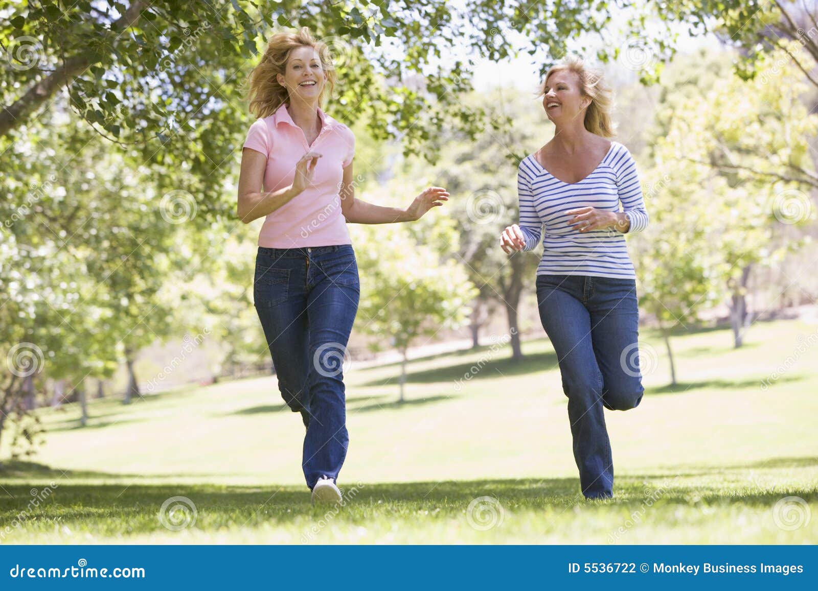 Two Women Running in Park and Smiling Stock Photo - Image of looking ...