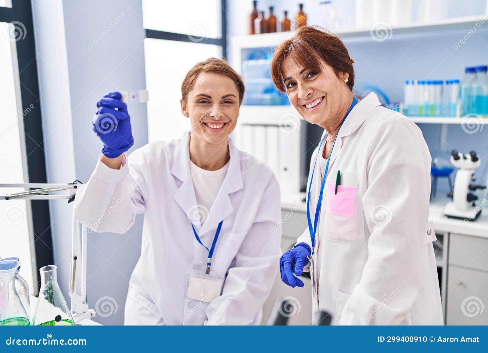 Two Women Scientist Smiling Confident Looking Sample at Laboratory ...