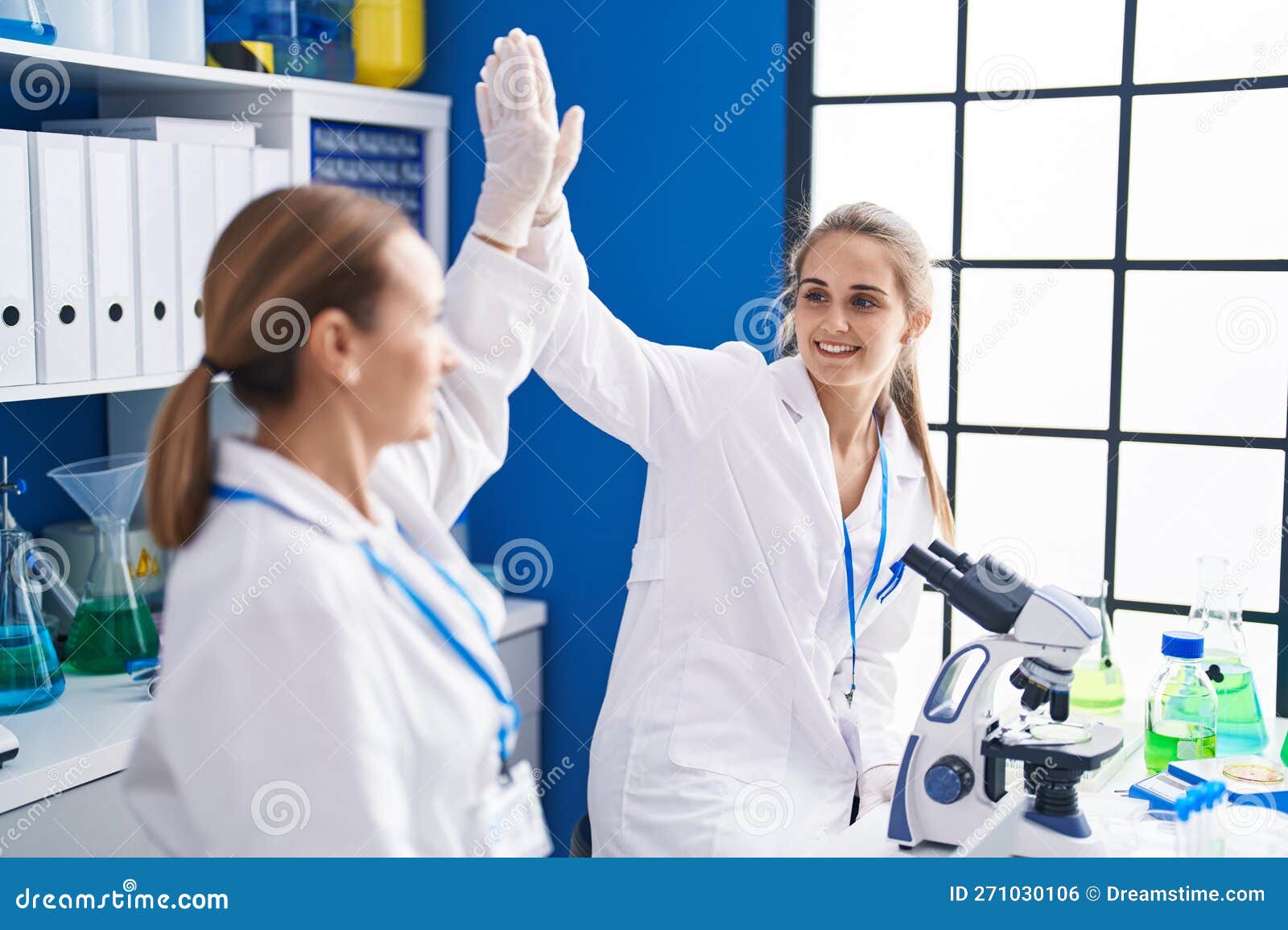 Two Women Scientists High Five with Hands Raised Up at Laboratory Stock ...