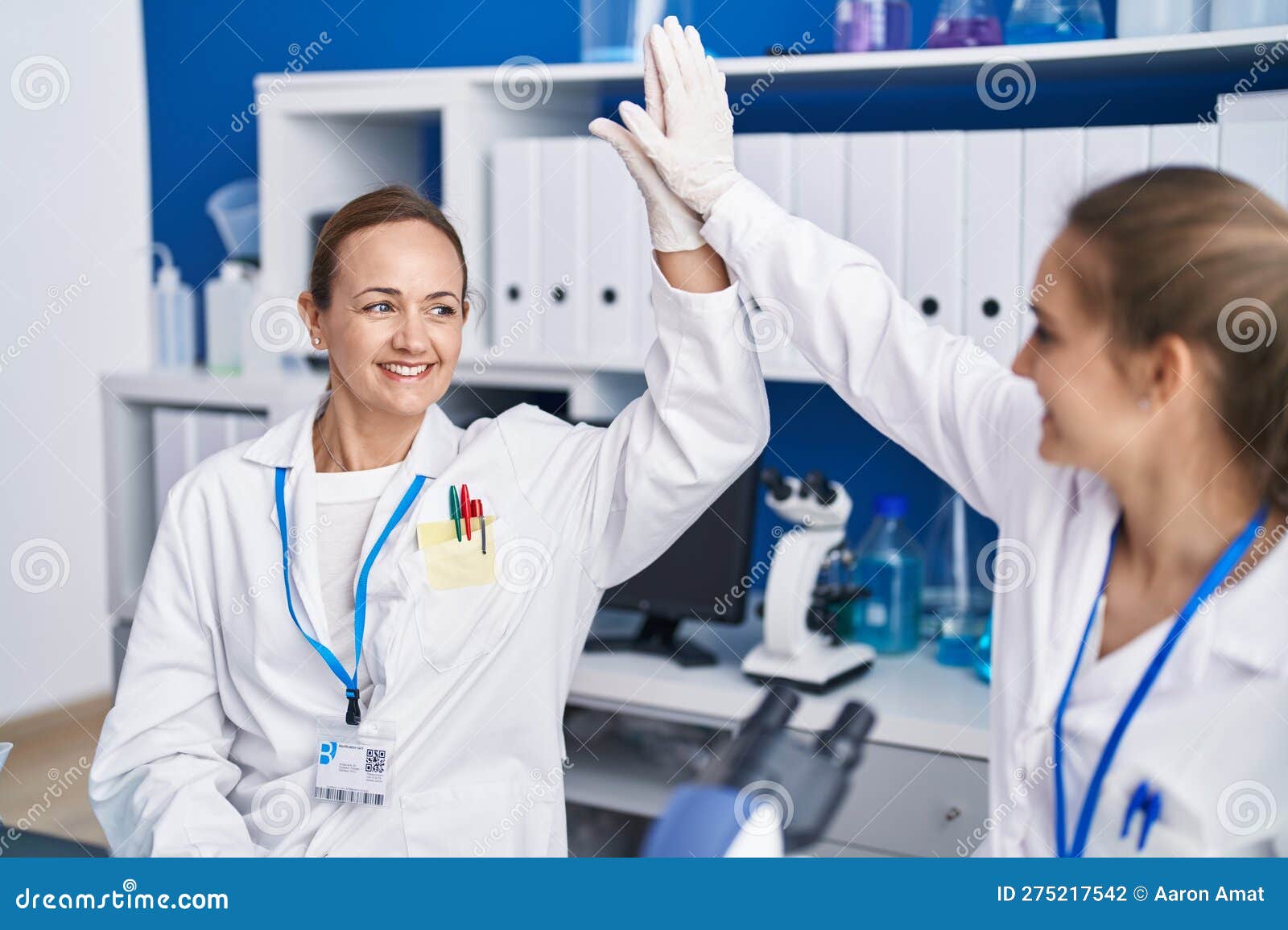 Two Women Scientists High Five with Hands Raised Up at Laboratory Stock ...