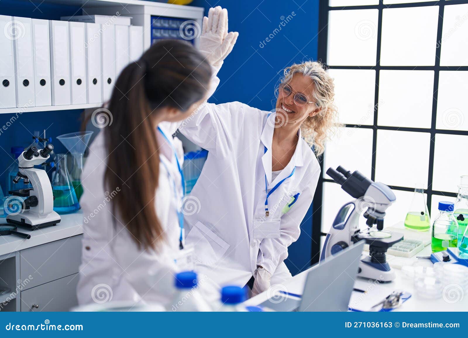 Two Women Scientists High Five with Hands Raised Up Working at ...