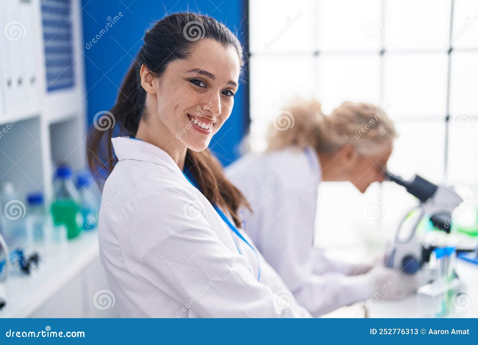 Two Women Scientists Using Microscope Working at Laboratory Stock Image ...