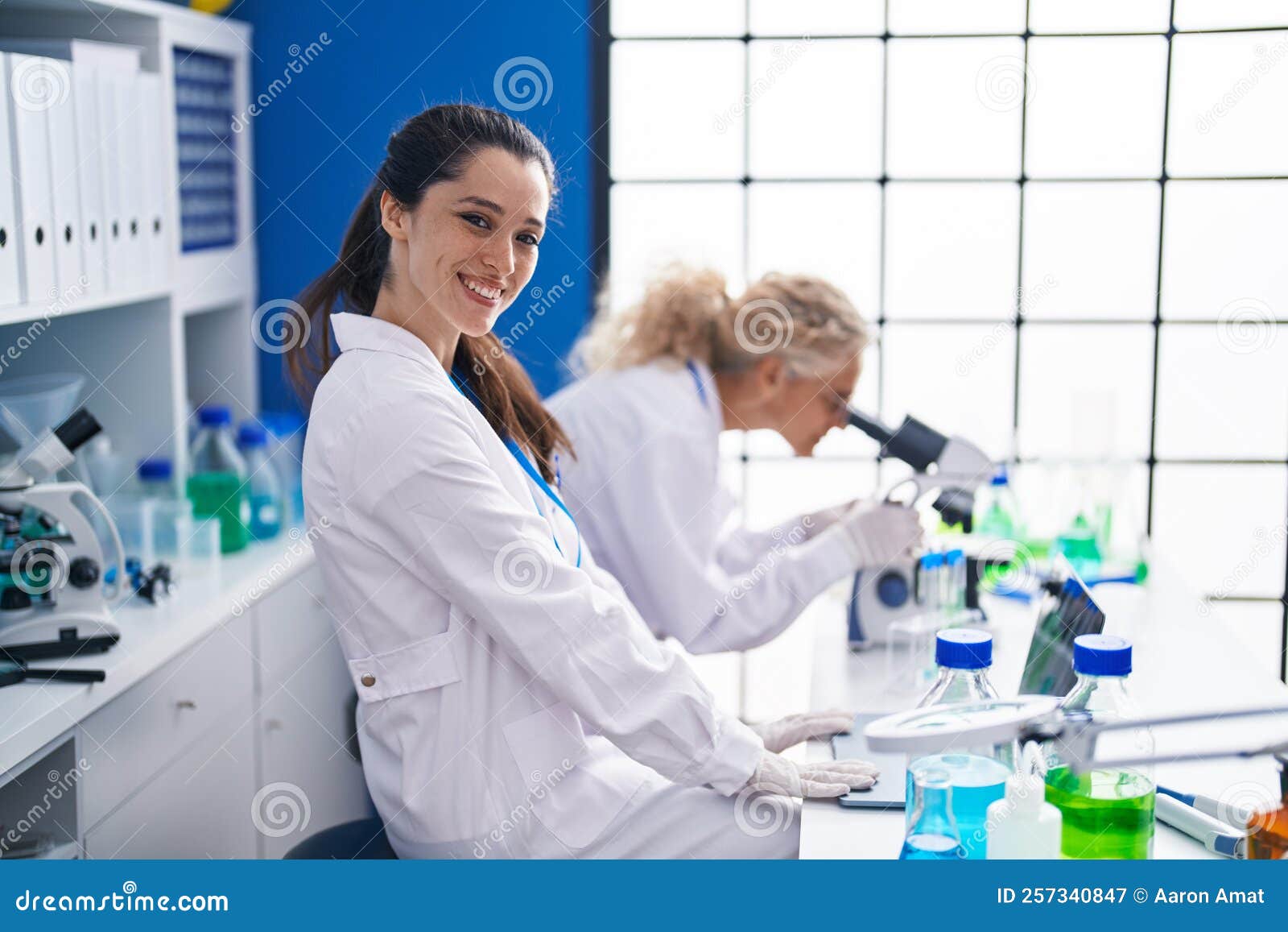 Two Women Scientists Using Microscope Working at Laboratory Stock Image ...